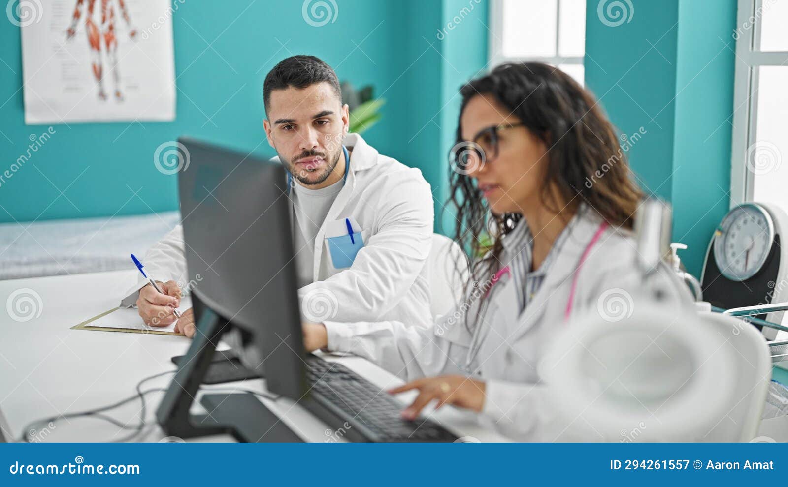 Man and Woman Doctors Using Computer Taking Notes Speaking at the ...