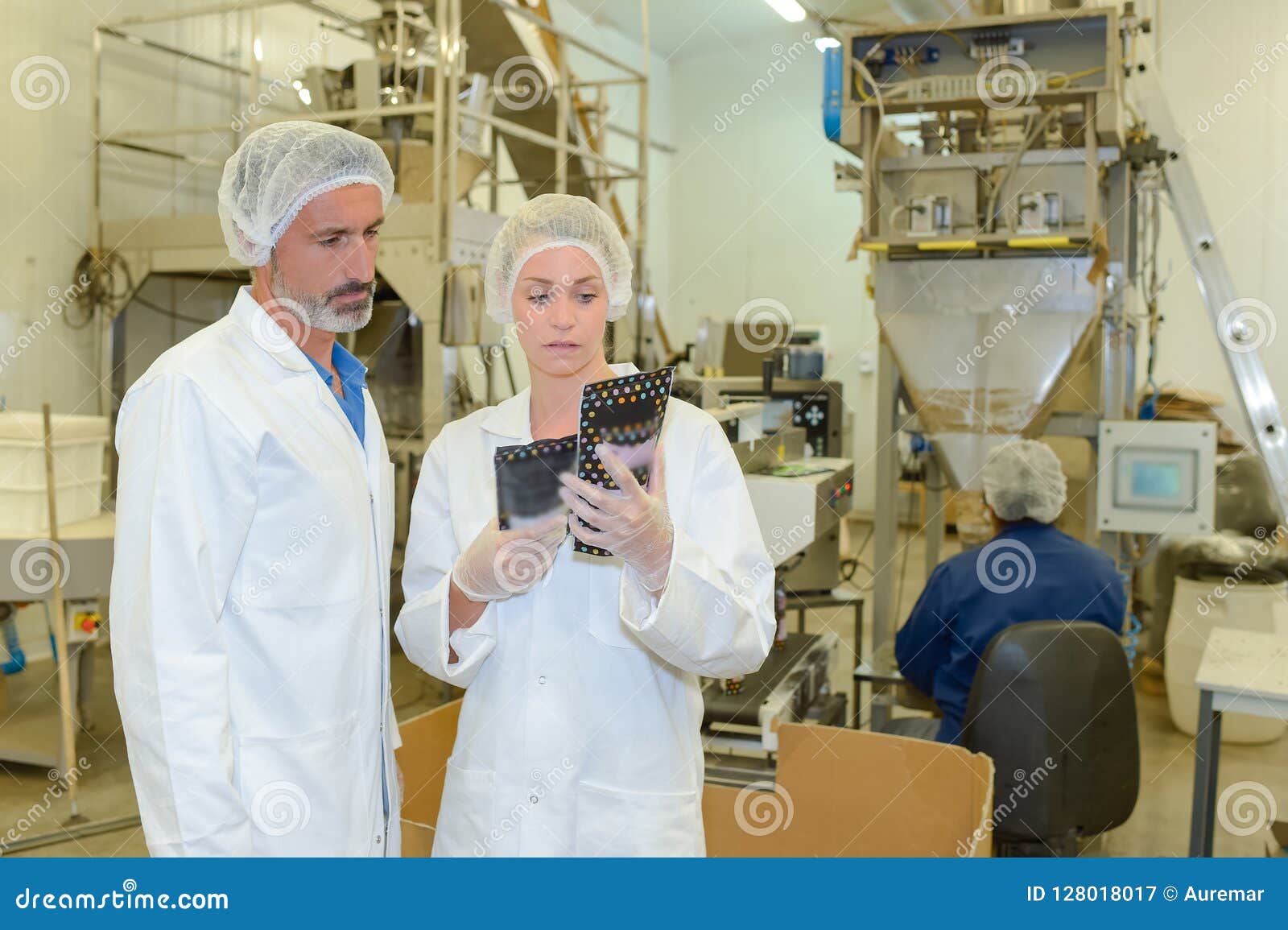 Man and Woman in Factory Comparing Products Stock Image - Image of ...
