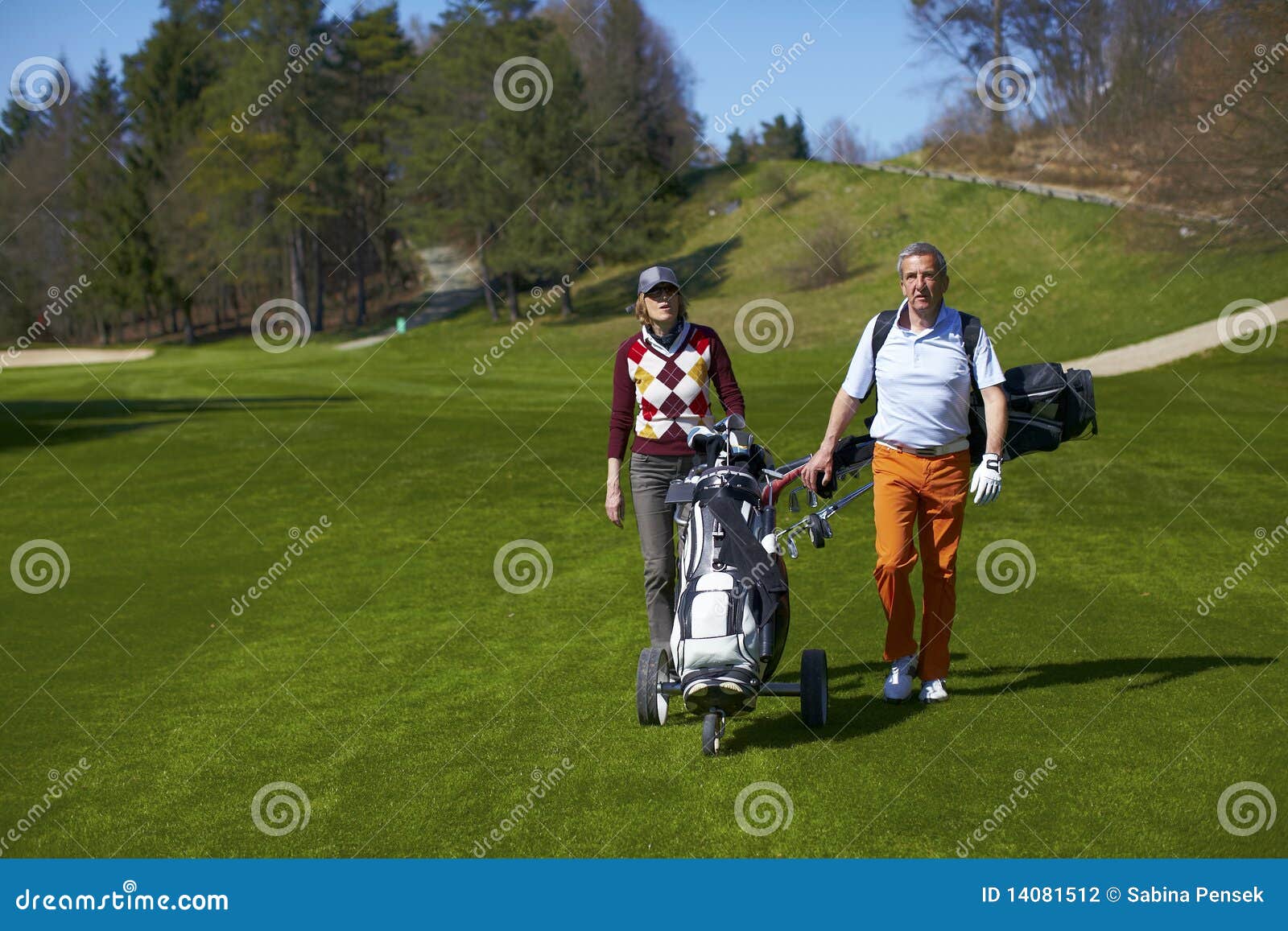 Man and Woman Golfers Walking on a Golf Course Stock Photo - Image of ...