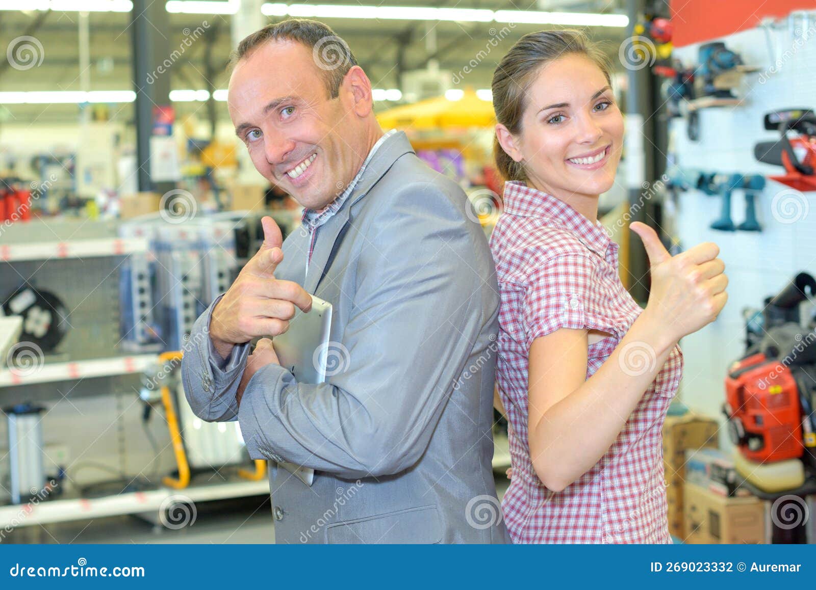 Man and Woman in Hardware Store Making Positive Hand Gestures Stock ...