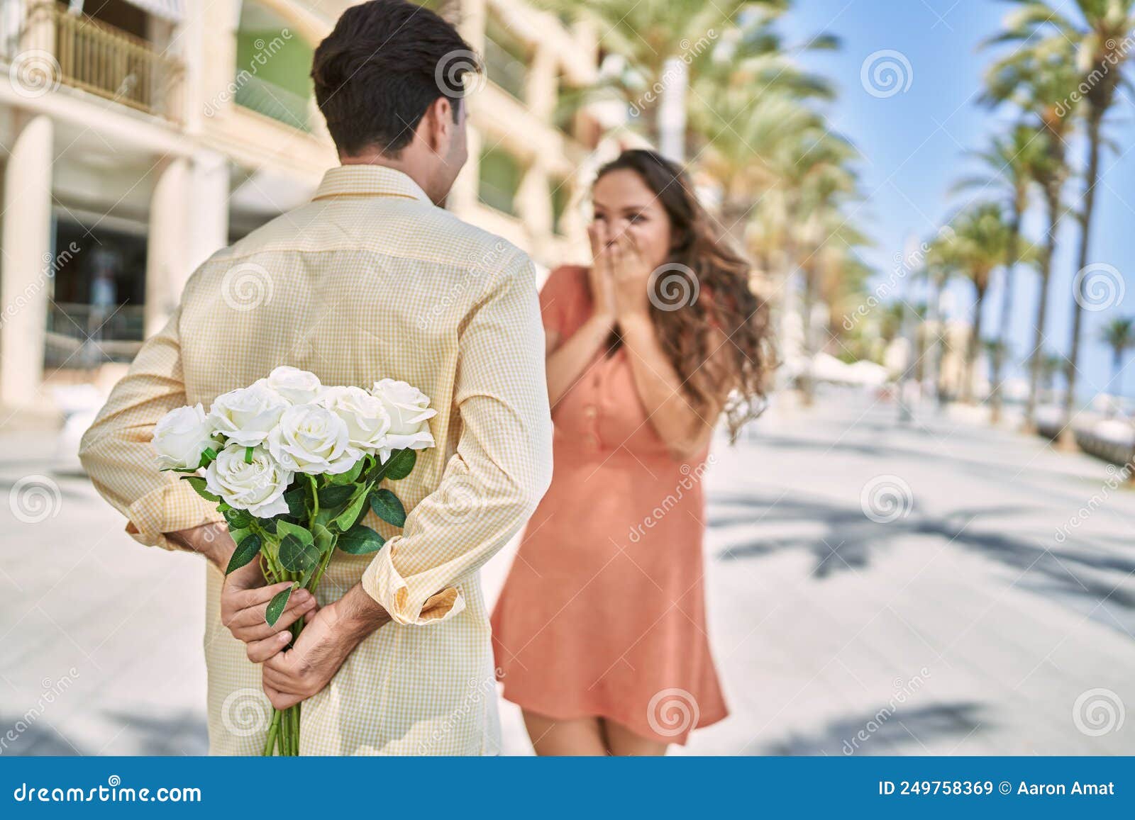 Man And Woman Having Anniversary Surprise Holding Bouquet Of Flowers At
