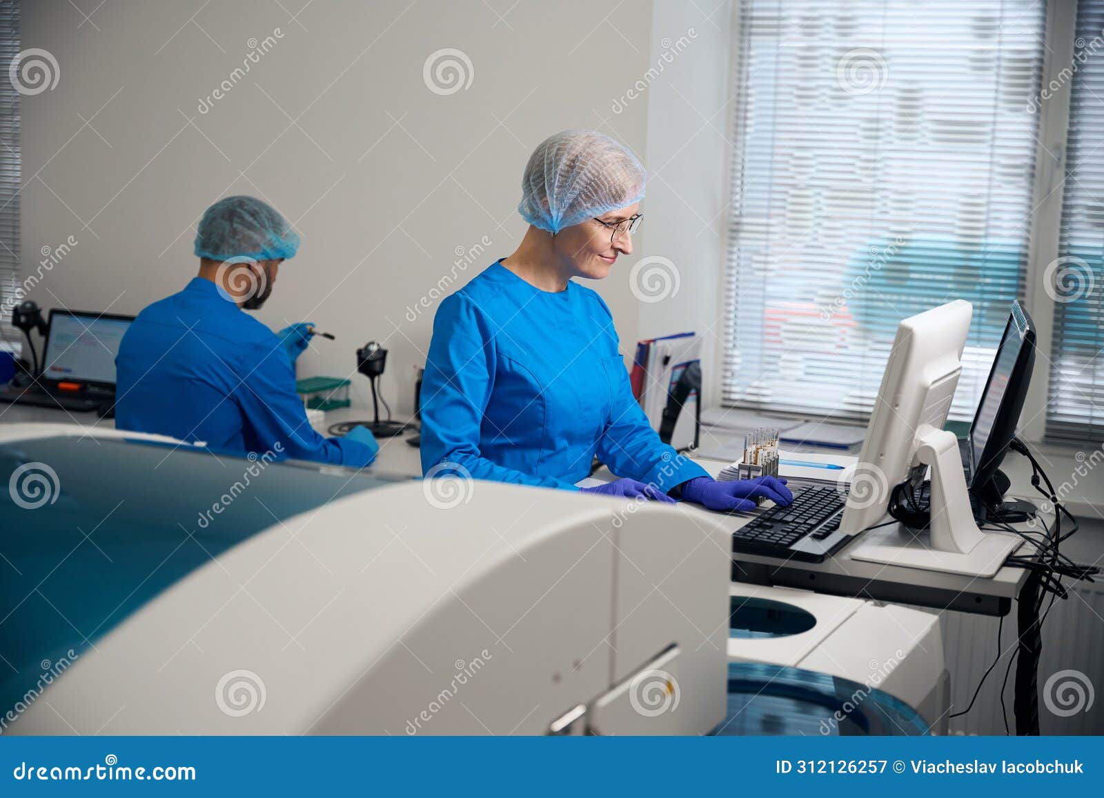 Man and Woman Laboratory Assistants Use Modern Computers at Work Stock ...