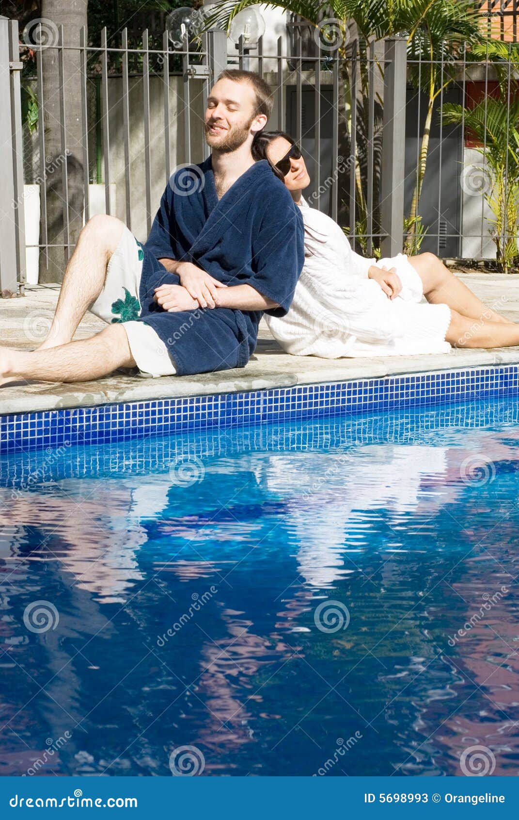 Man and Woman Lounging beside a Pool - Vertical Stock Image - Image of ...