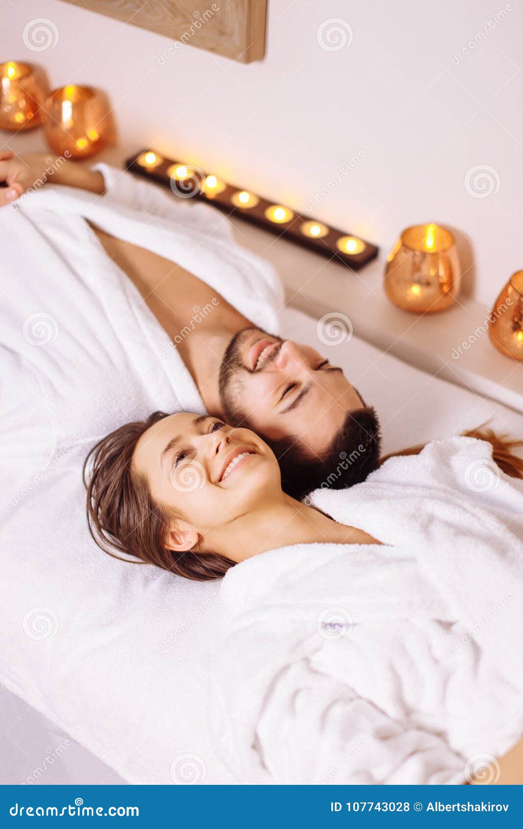 Man And Woman Lying Down On Massage Beds At Luxury Spa And Wellness