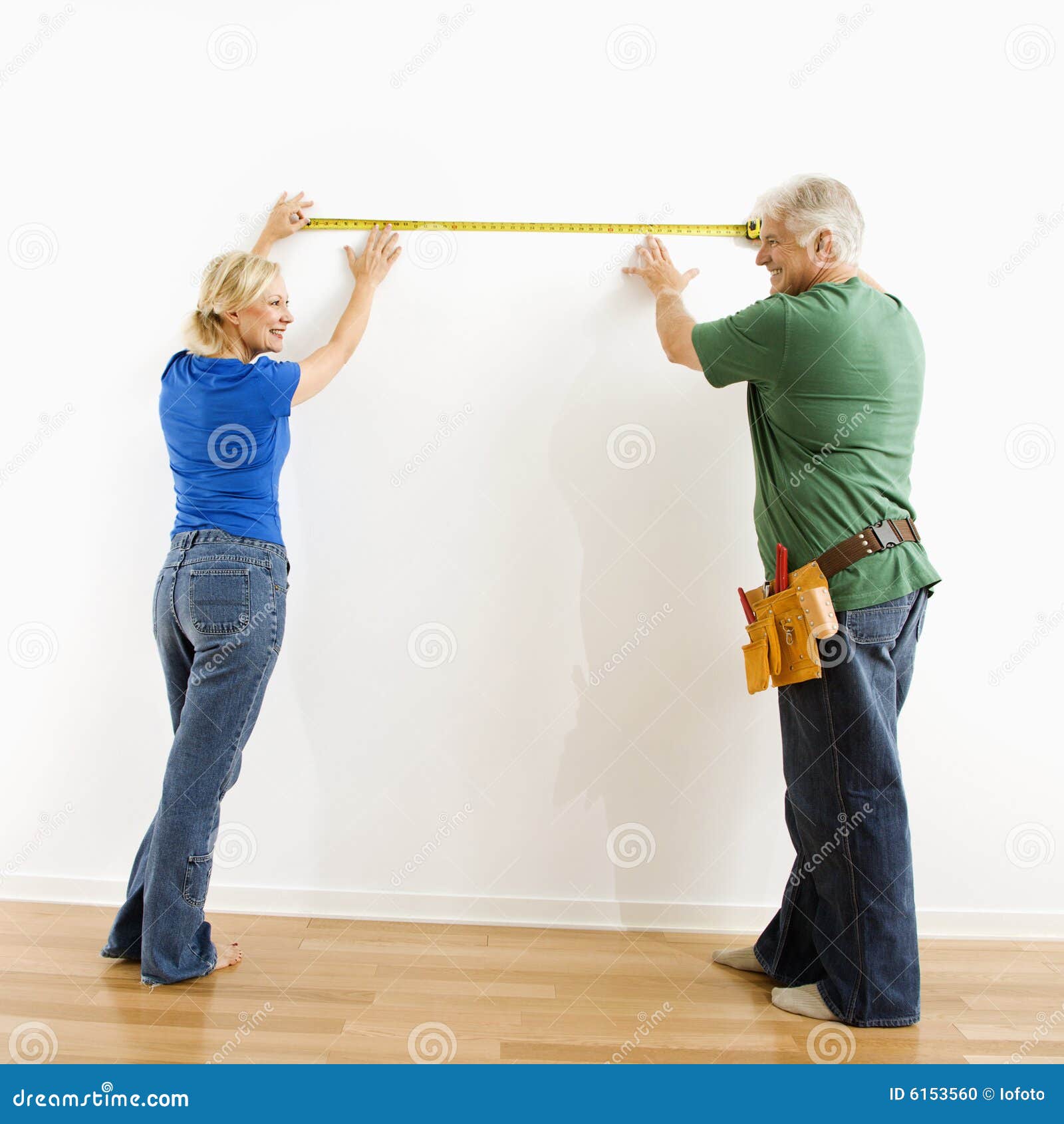 Man and Woman Measuring Wall. Stock Photo - Image of house, hair: 6153560