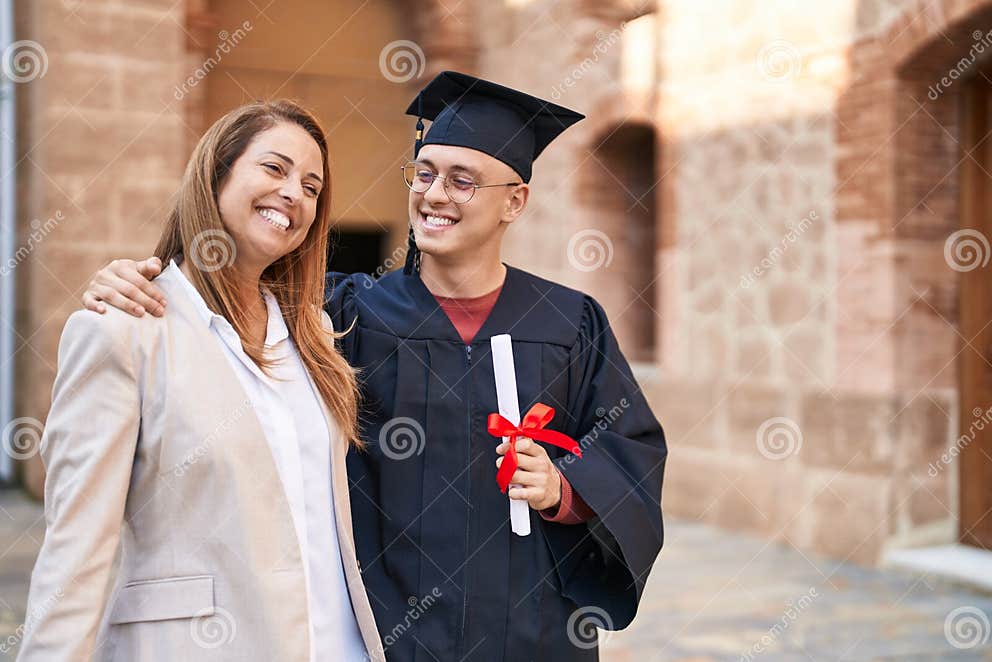 Man And Woman Mother And Son Hugging Each Other Celebrating Graduation