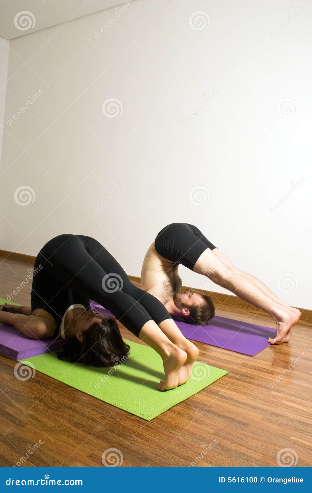 Man and Woman Performing Yoga Exercise - Vertical Stock Photo - Image ...