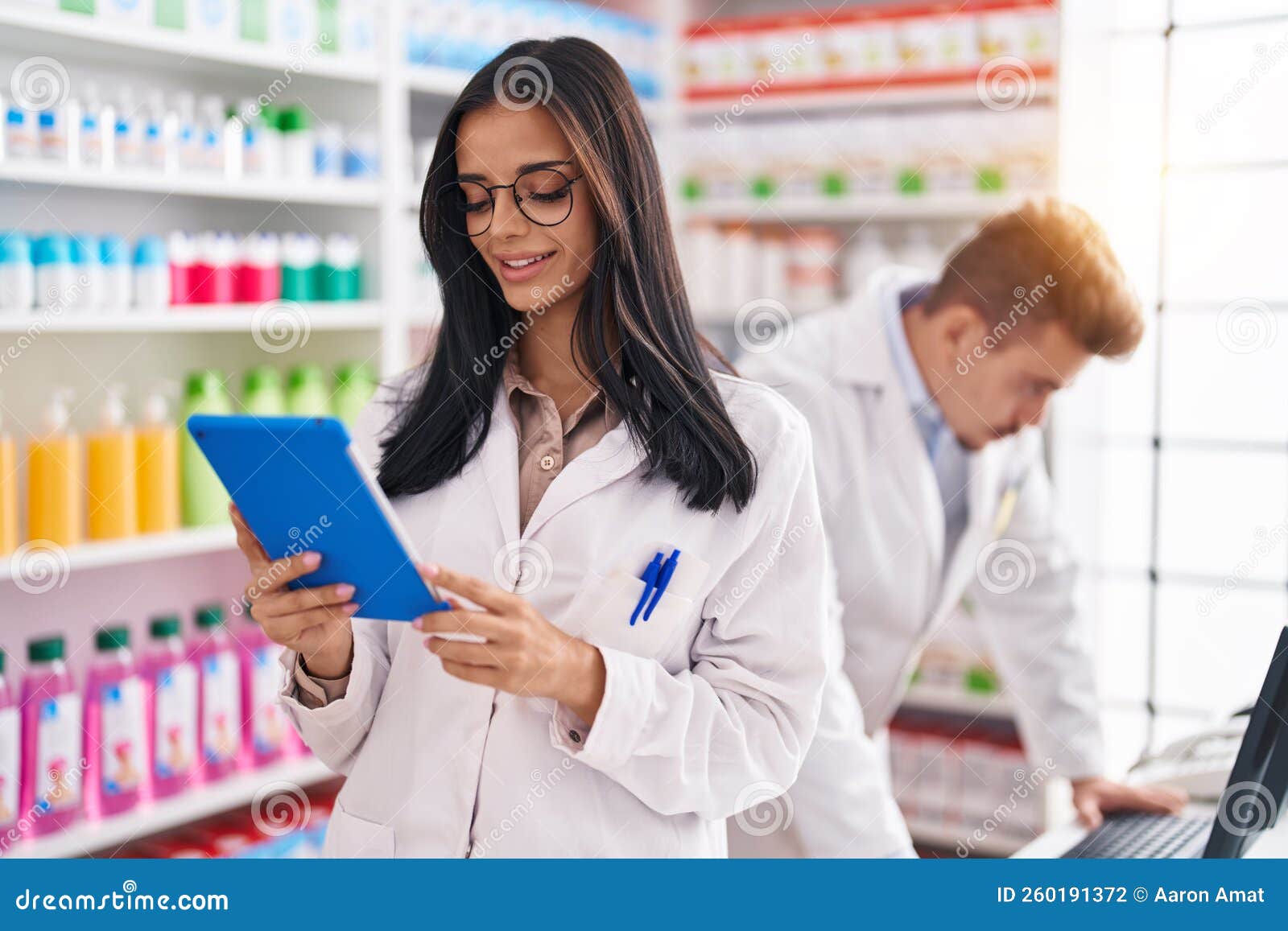 Man and Woman Pharmacists Using Touchpad and Computer Working at ...