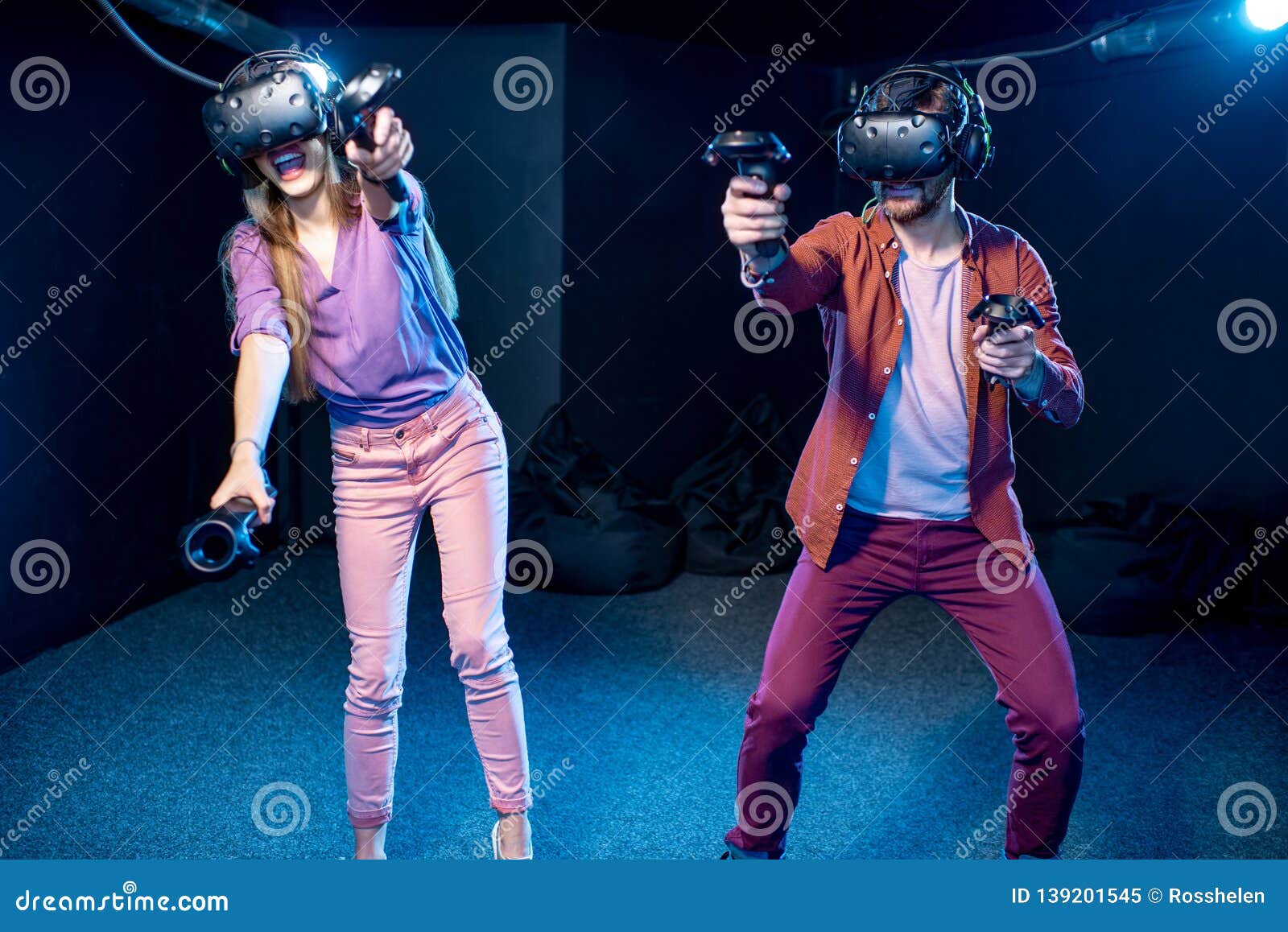 Man and Woman Playing Game with Virtual Reality Headset in the Club ... Man and Woman Playing Game with Virtual Reality Headset in the Club ...