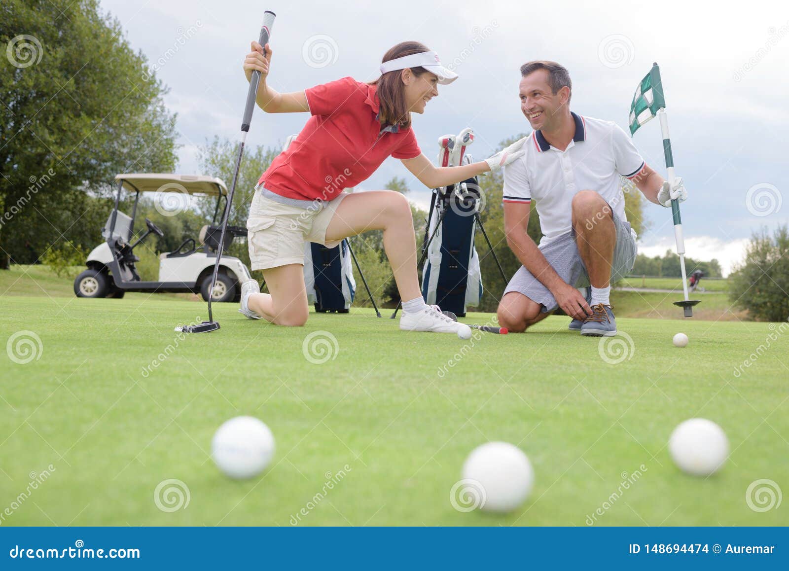 Man and woman playing golf stock photo. Image of activities - 148694474