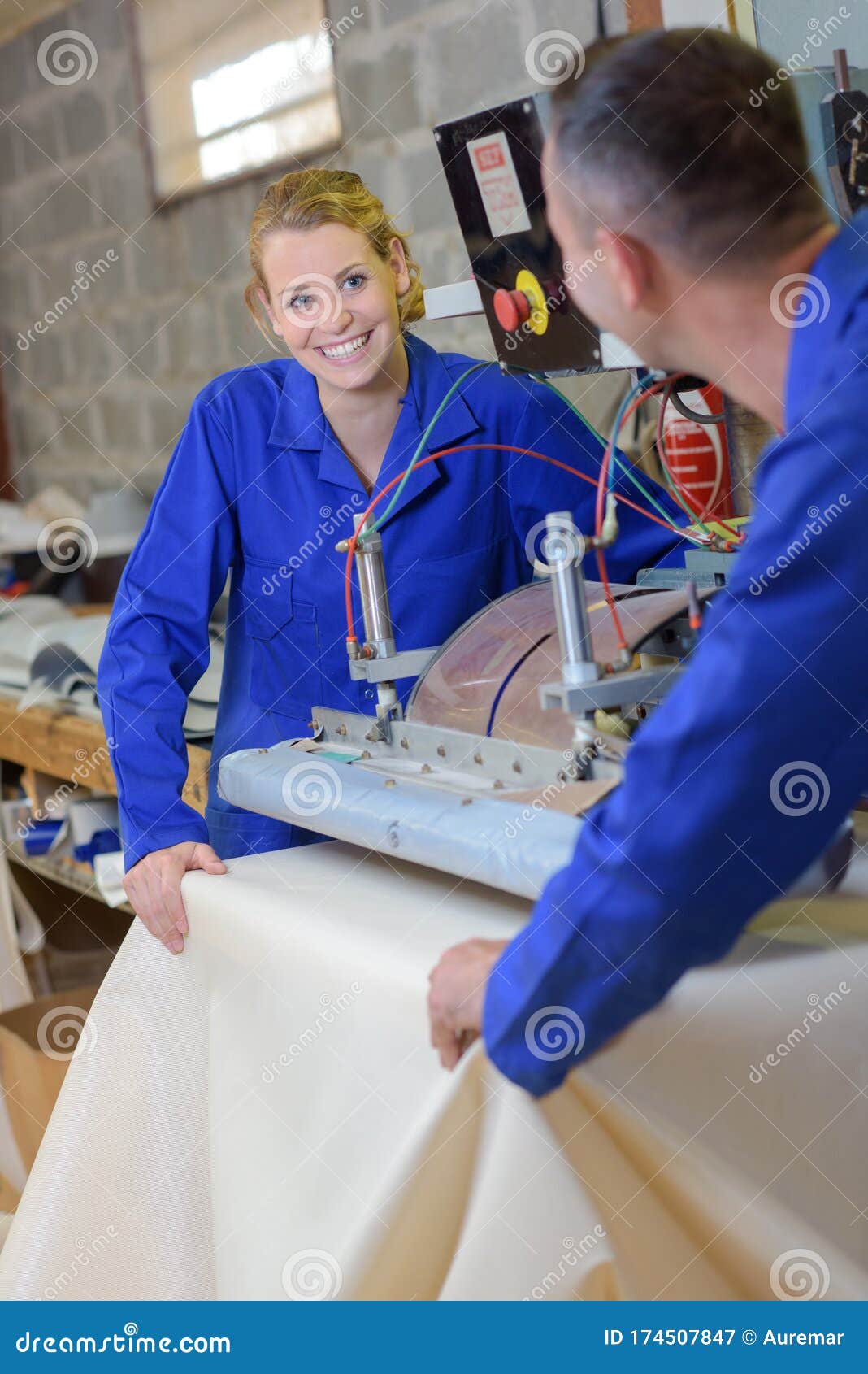 Man and Woman Pulling Material through Machine Stock Image - Image of ...