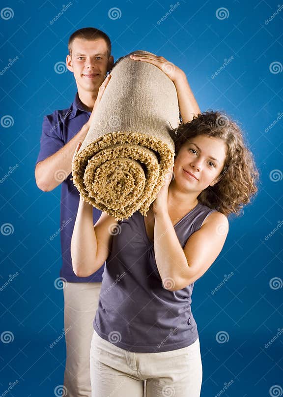Man and Woman with Rolled Carpet Stock Photo - Image of couple, floor ...