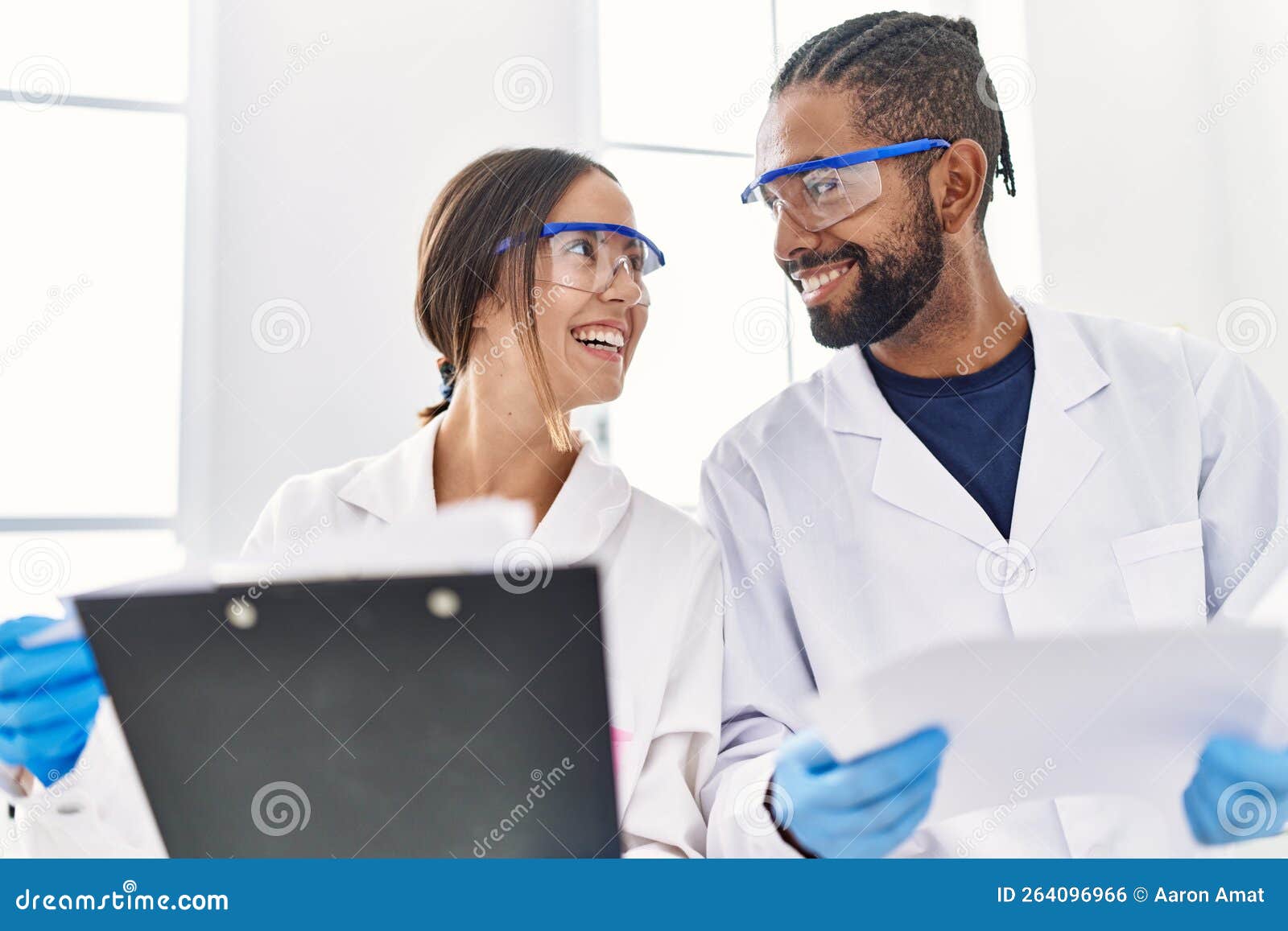 Man and Woman Scientist Partners Reading Documents at Laboratory Stock ...