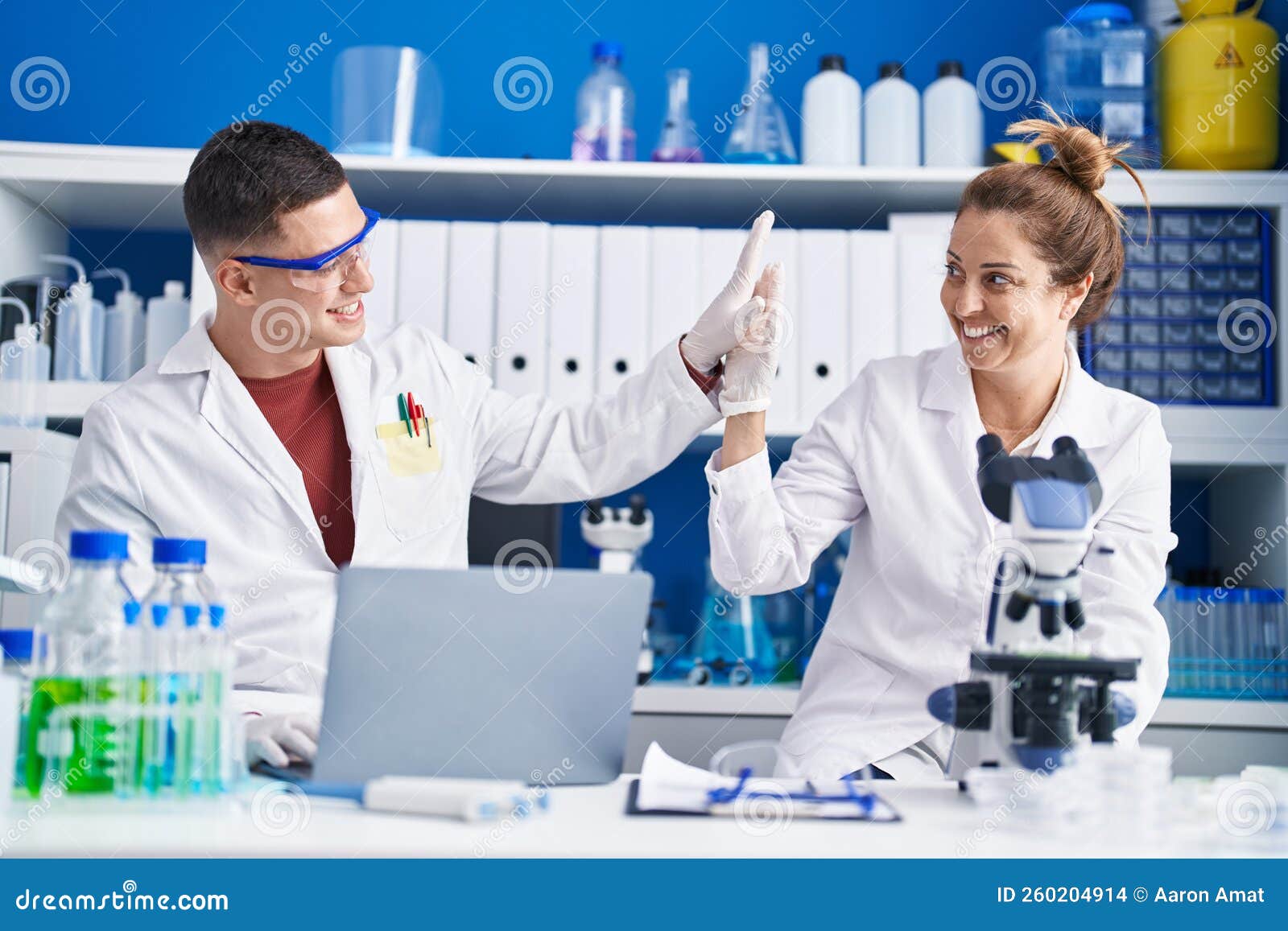 Man and Woman Scientists High Five with Hands Raised Up at Laboratory ...