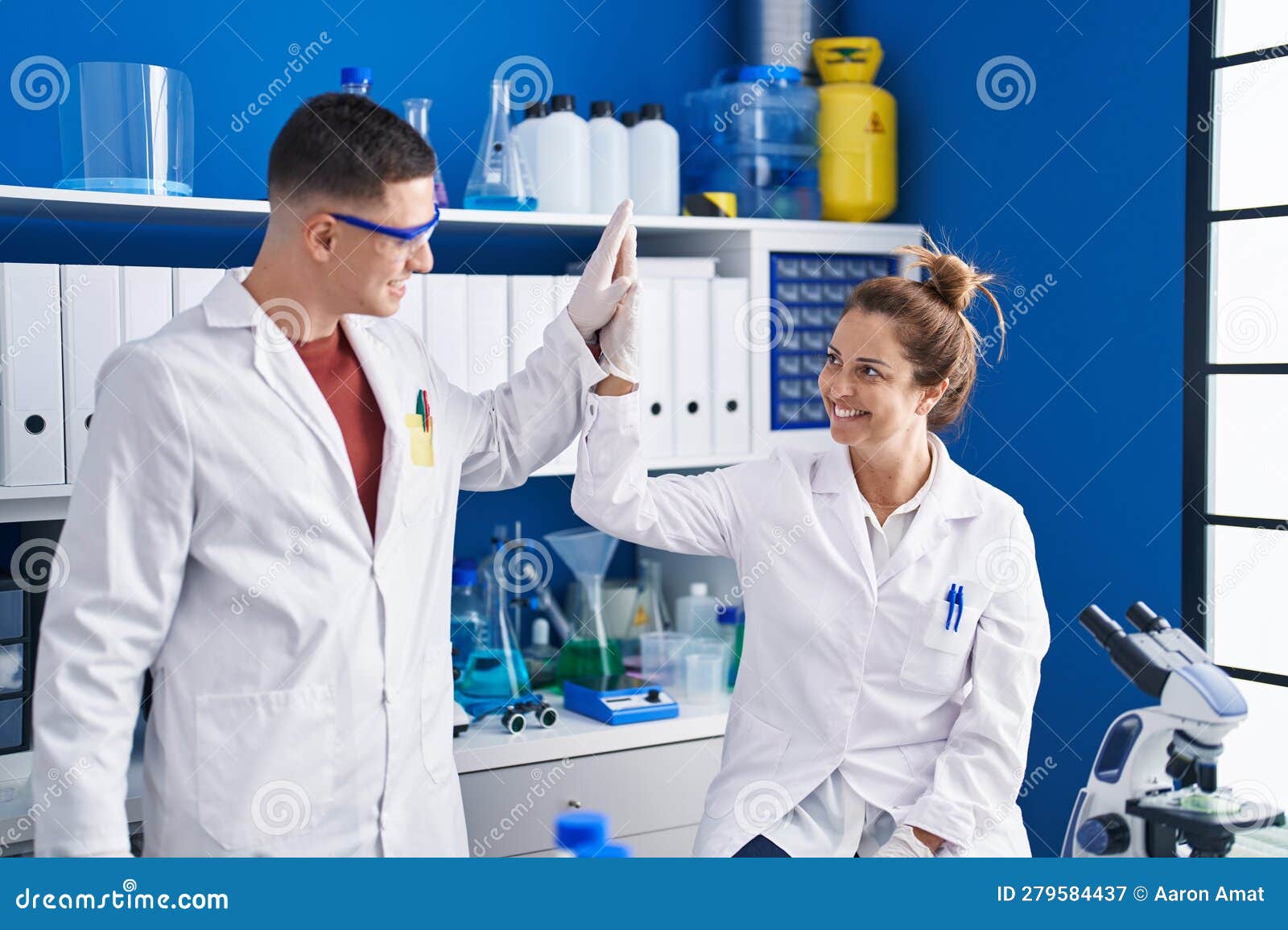 Man and Woman Scientists High Five with Hands Raised Up at Laboratory ...