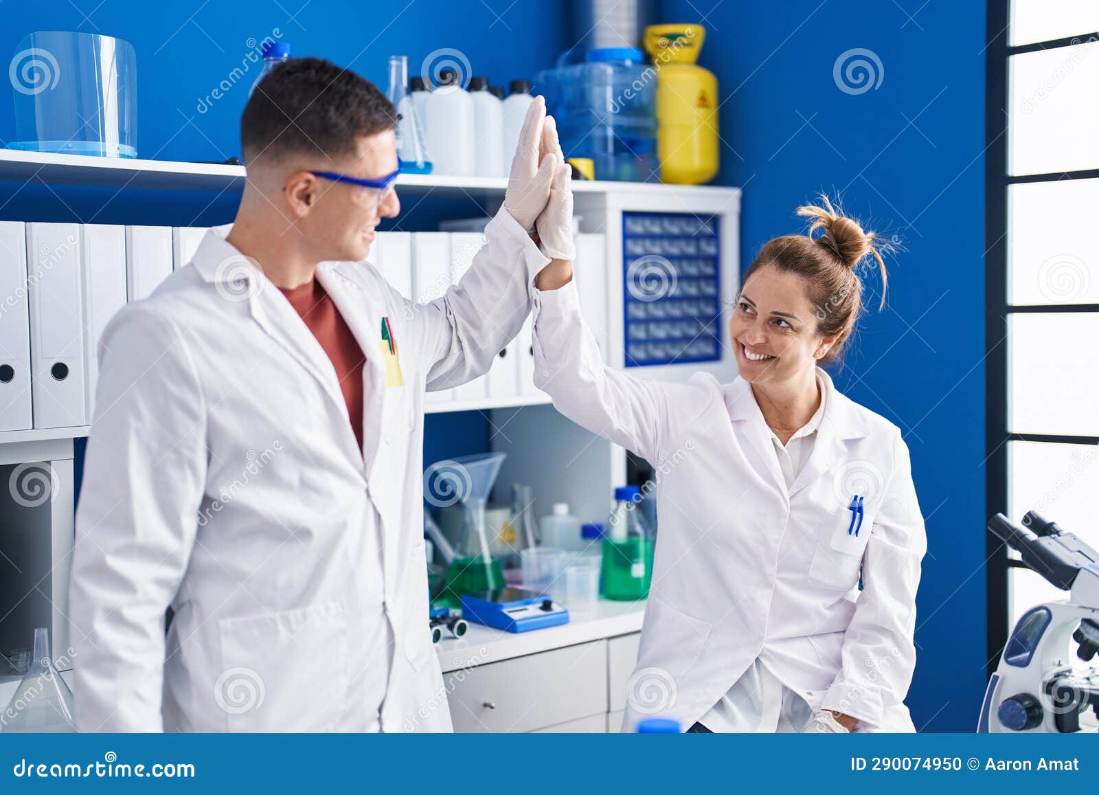 Man and Woman Scientists High Five with Hands Raised Up at Laboratory ...