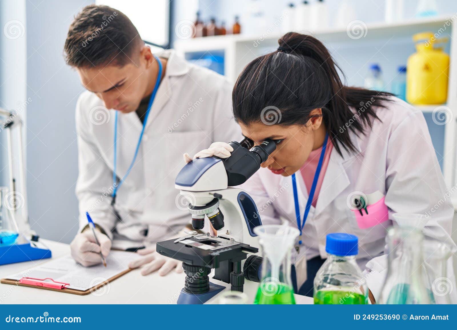 Man and Woman Scientists Partners Using Microscope Working at ...