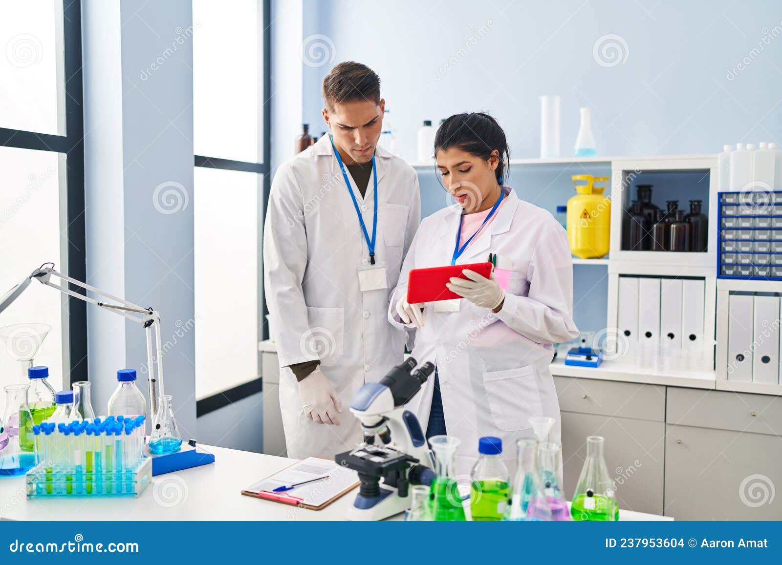 Man and Woman Scientists Partners Using Touchpad at Laboratory Stock ...