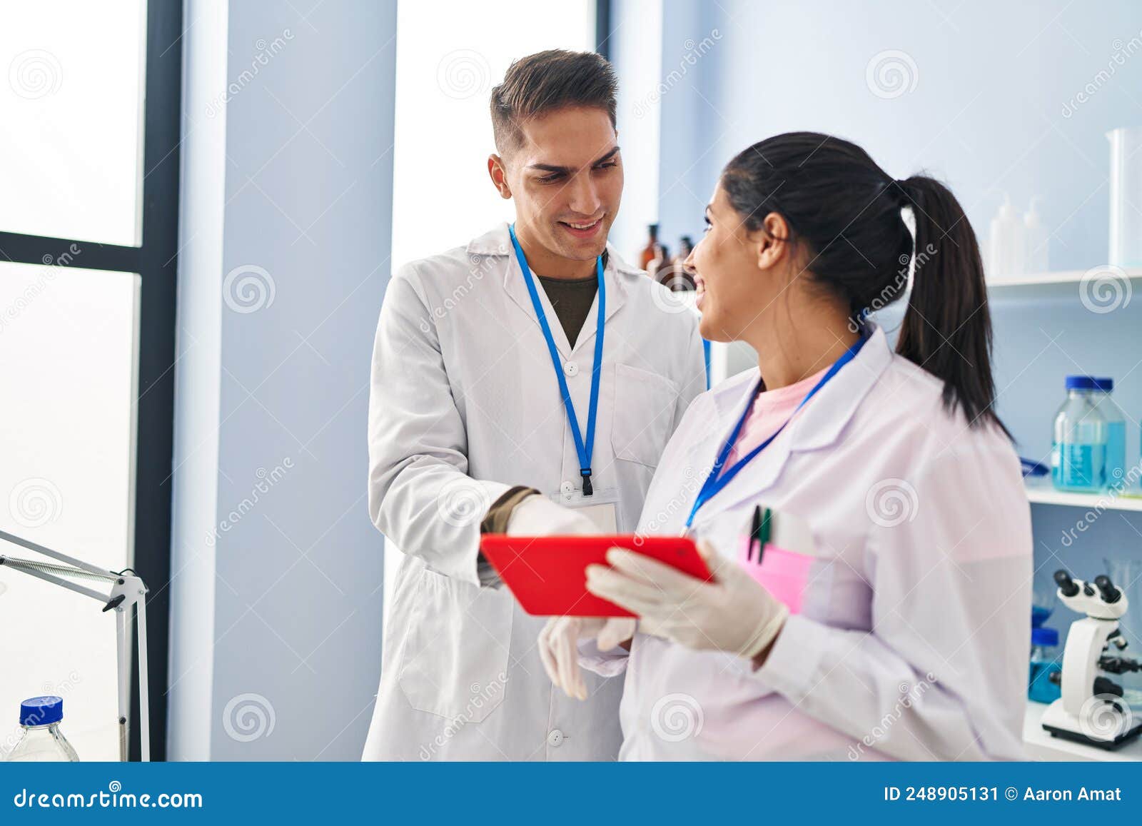 Man and Woman Scientists Partners Using Touchpad at Laboratory Stock ...