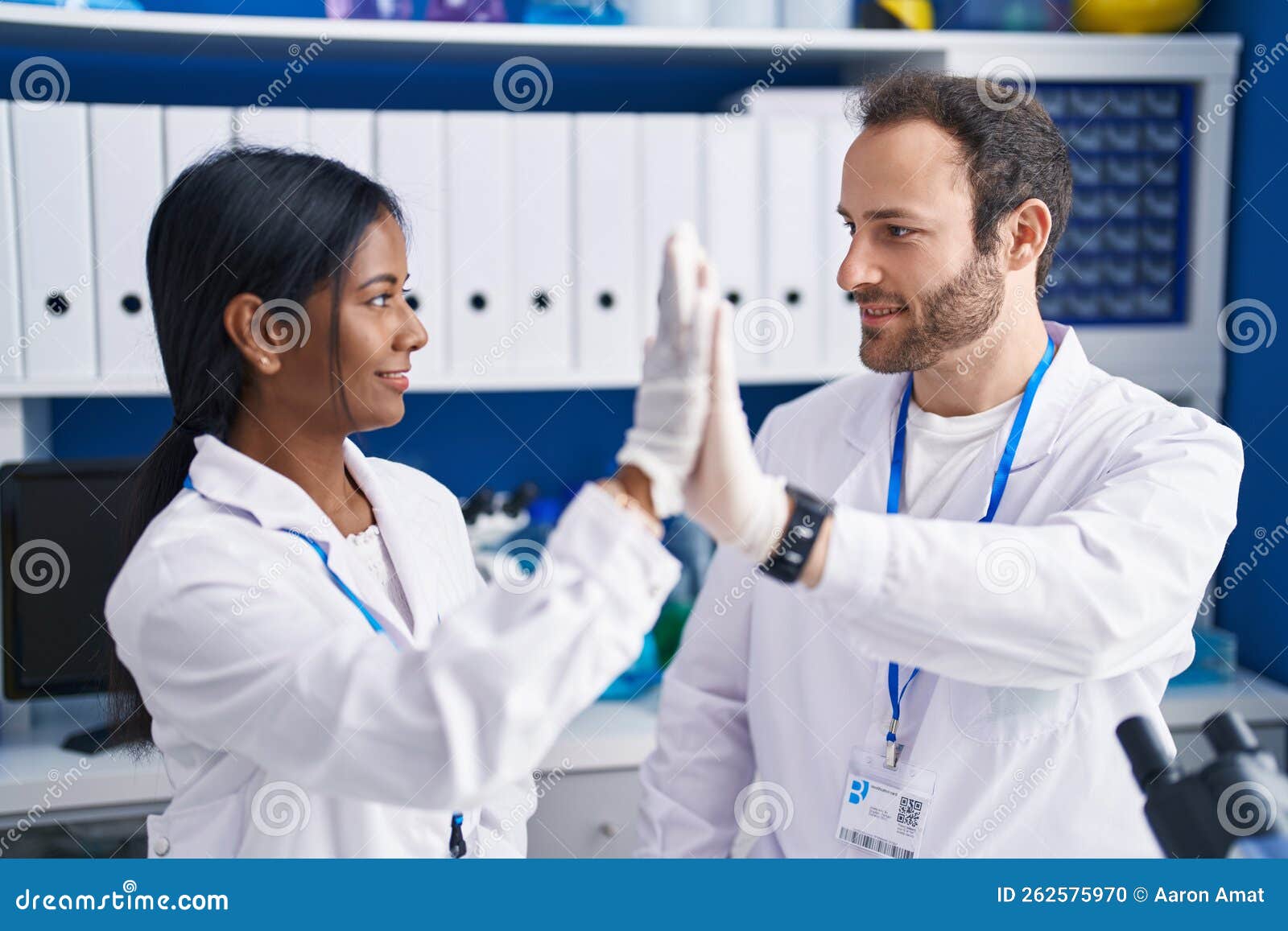 Man and Woman Scientists Smiling Confident High Five at Laboratory ...