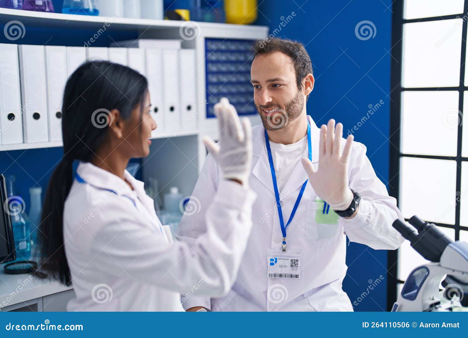 Man and Woman Scientists Smiling Confident High Five at Laboratory ...