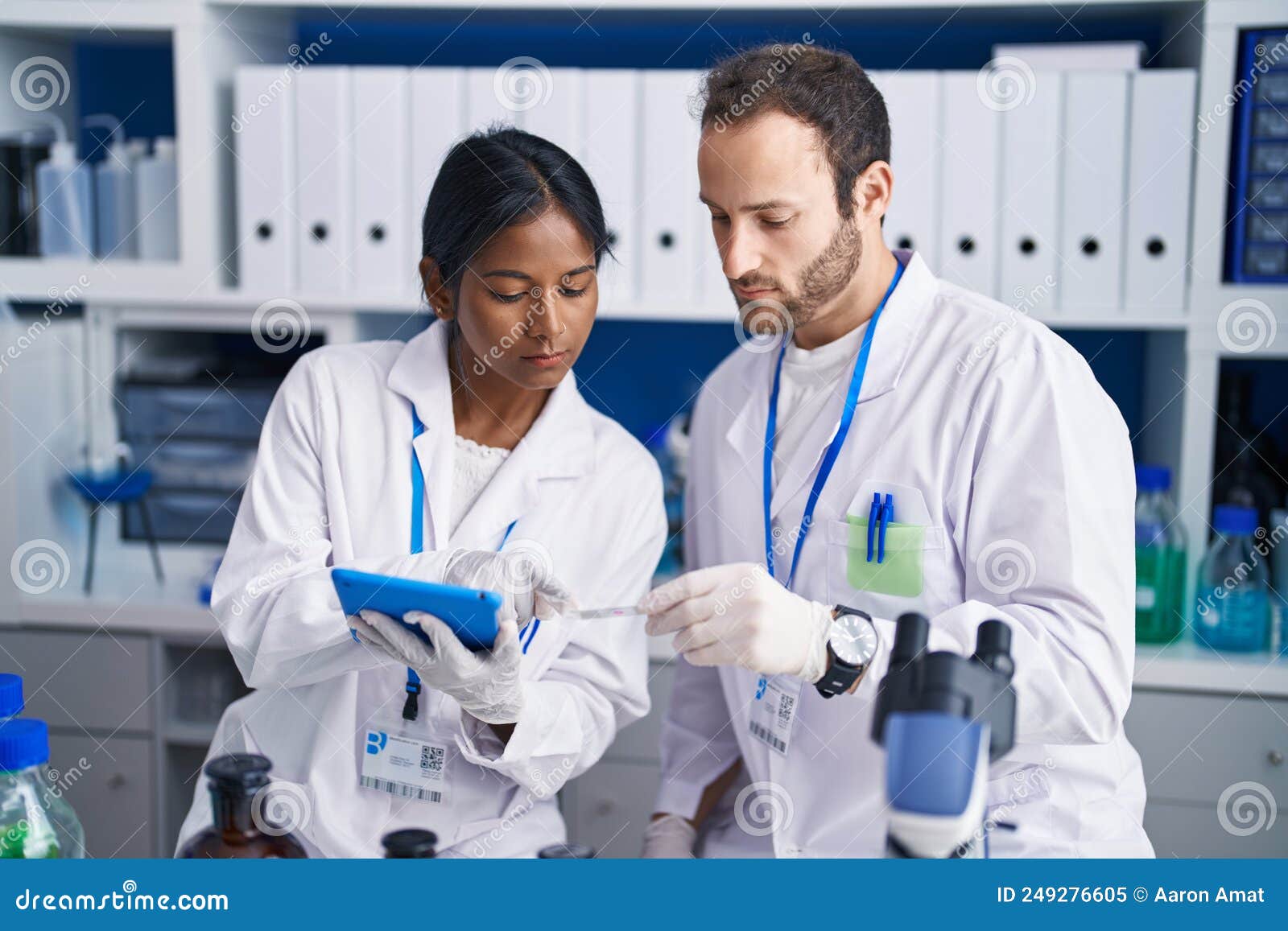 Man and Woman Scientists Using Touchpad Holding Sample at Laboratory ...