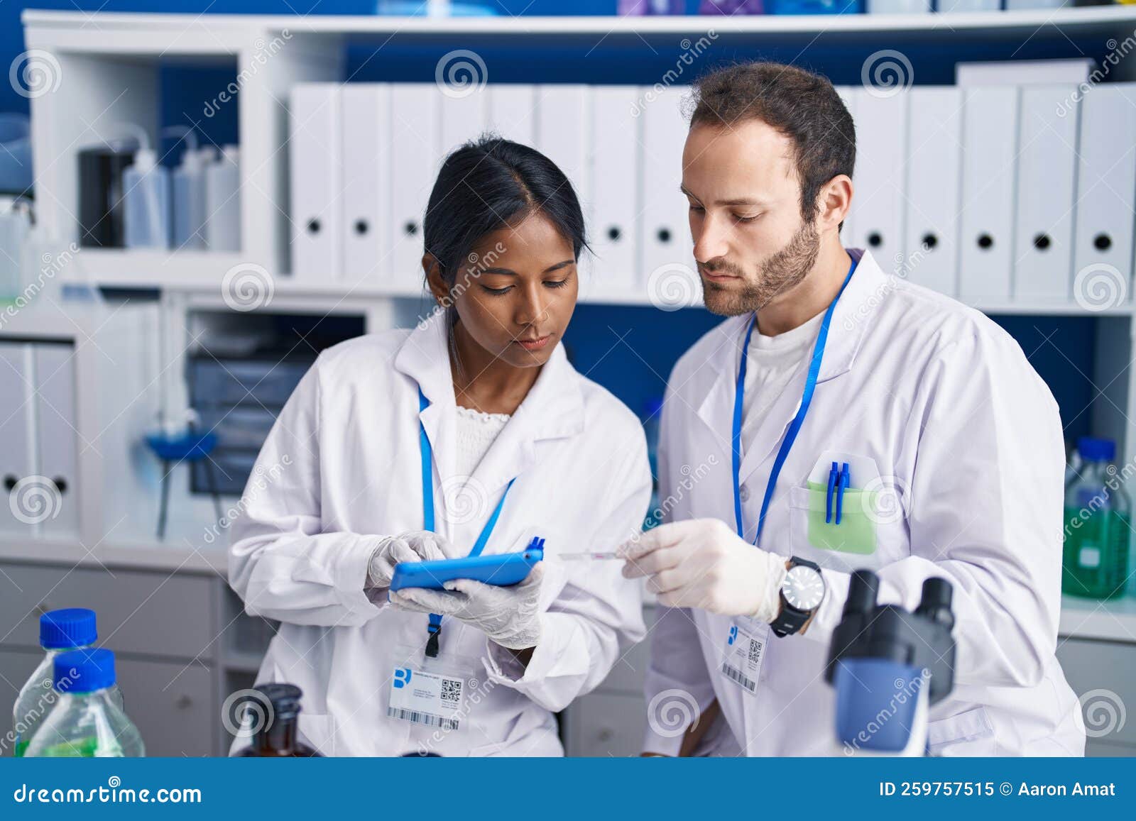 Man and Woman Scientists Using Touchpad Holding Sample at Laboratory ...