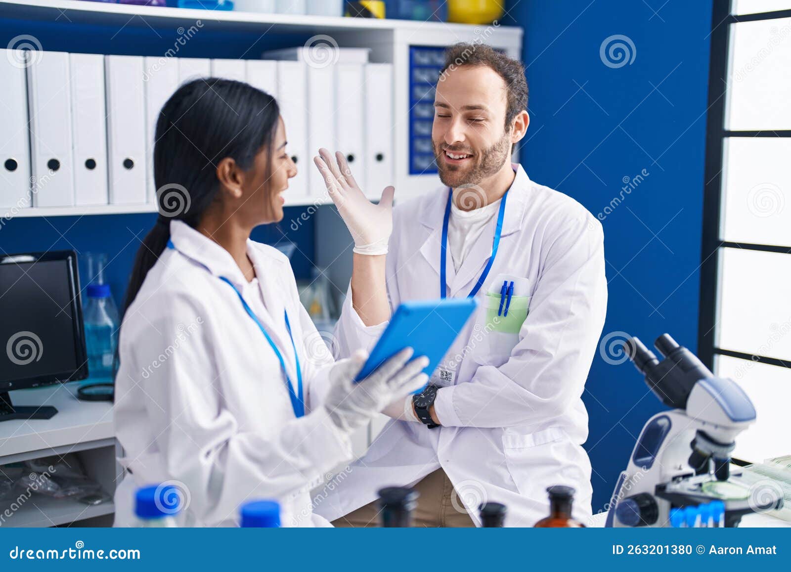 Man and Woman Scientists Using Touchpad Working at Laboratory Stock ...