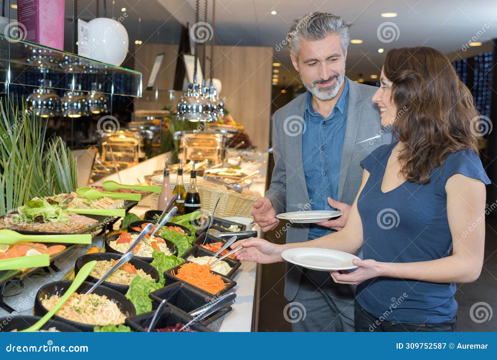 Man and Woman Serving Themselves at Buffet Counter Stock Image - Image ...