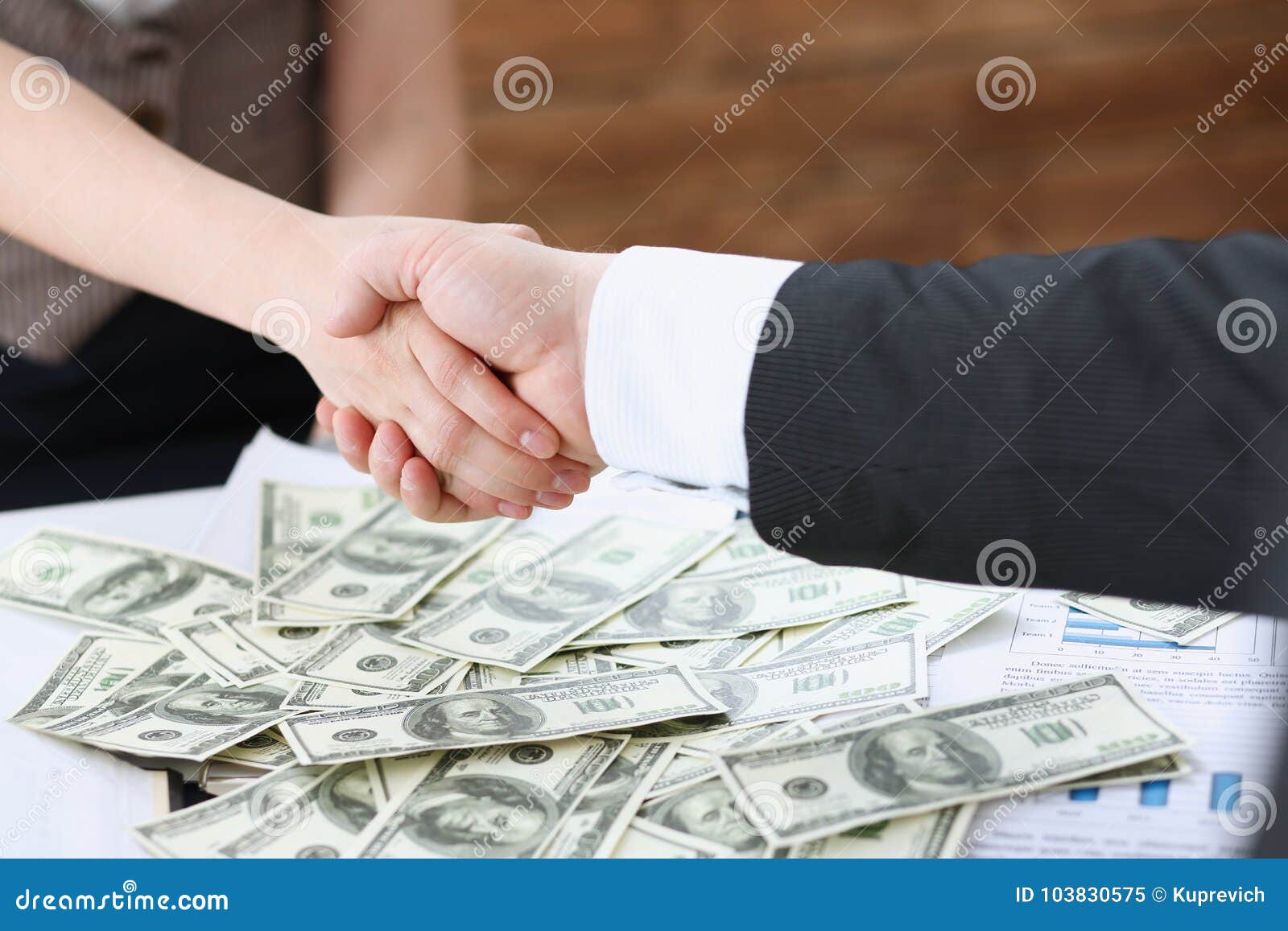 Man and Woman Shake Hands Over Stack Stock Image - Image of financial ...