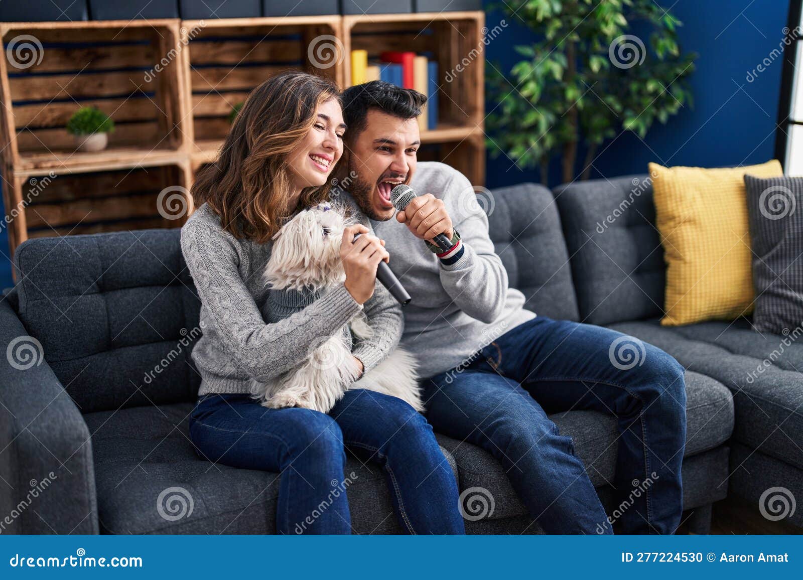 Man and Woman Singing Song Sitting on Sofa with Dog at Home Stock Photo ... Man and Woman Singing Song Sitting on Sofa with Dog at Home Stock Photo ...