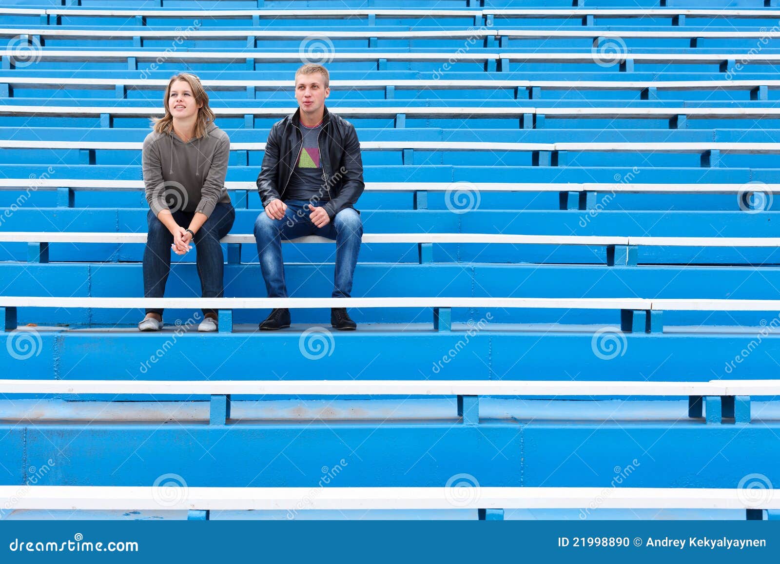 Man and Woman Sitting on Grandstand Stock Photo - Image of horizontal ...