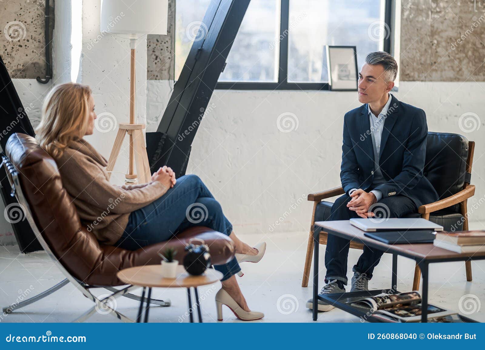 Man and Woman Sitting Opposite Each Other and Talking Stock Photo ...