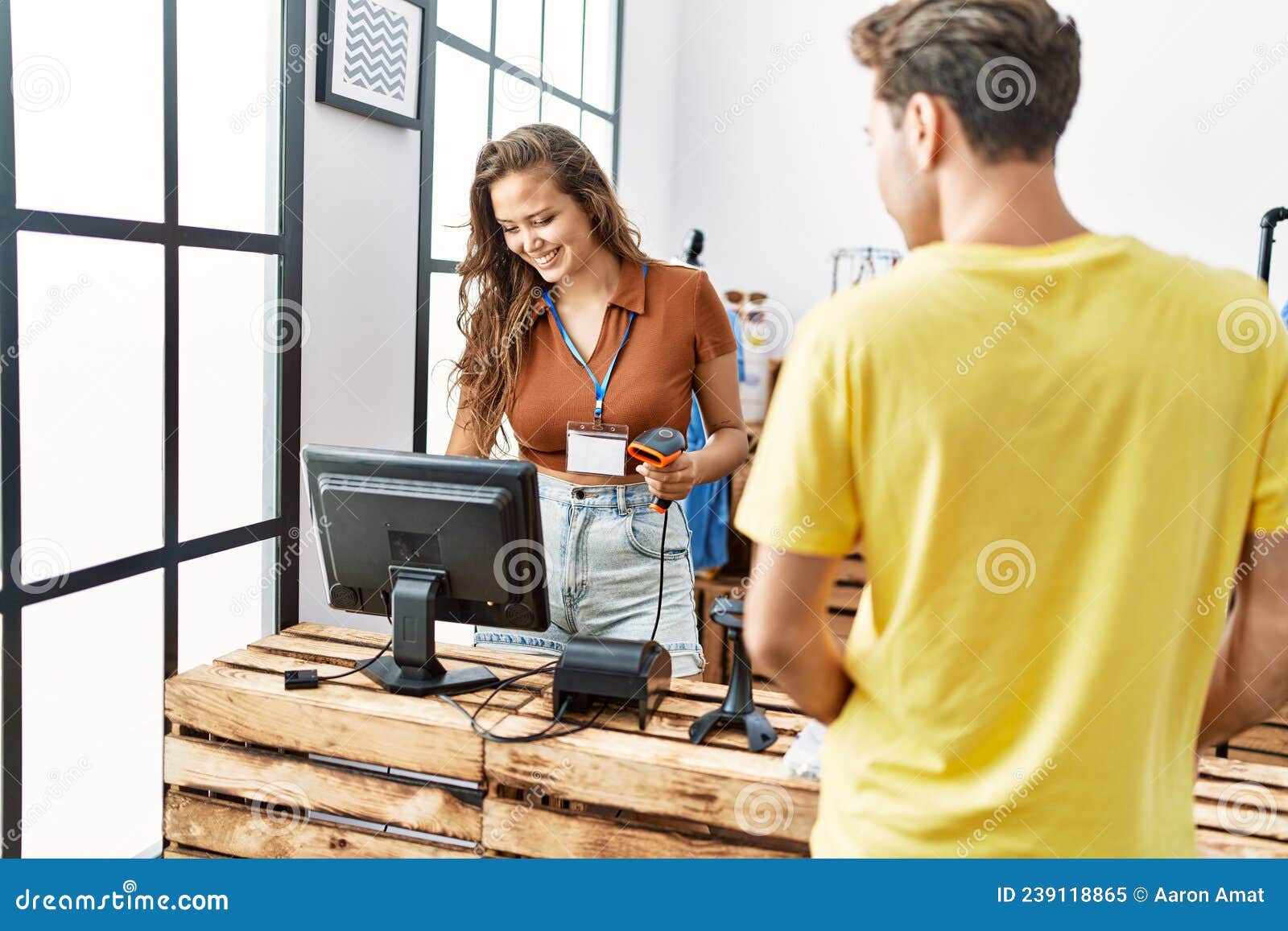 Man and Woman Smiling Confident Using Barcode Reader at Clothing Store ...