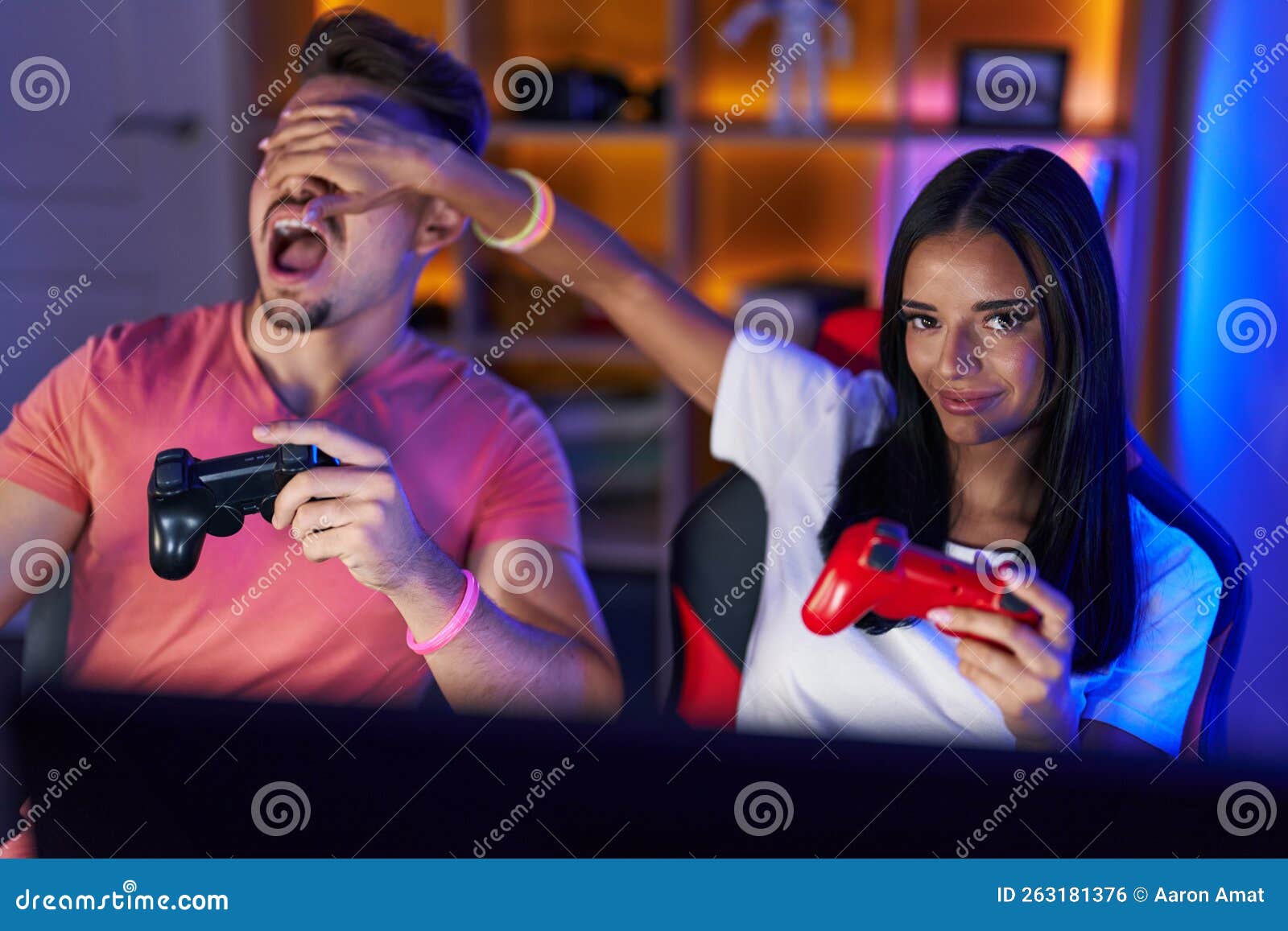 Man and Woman Streamers Playing Video Game Using Computer and Joystick ...