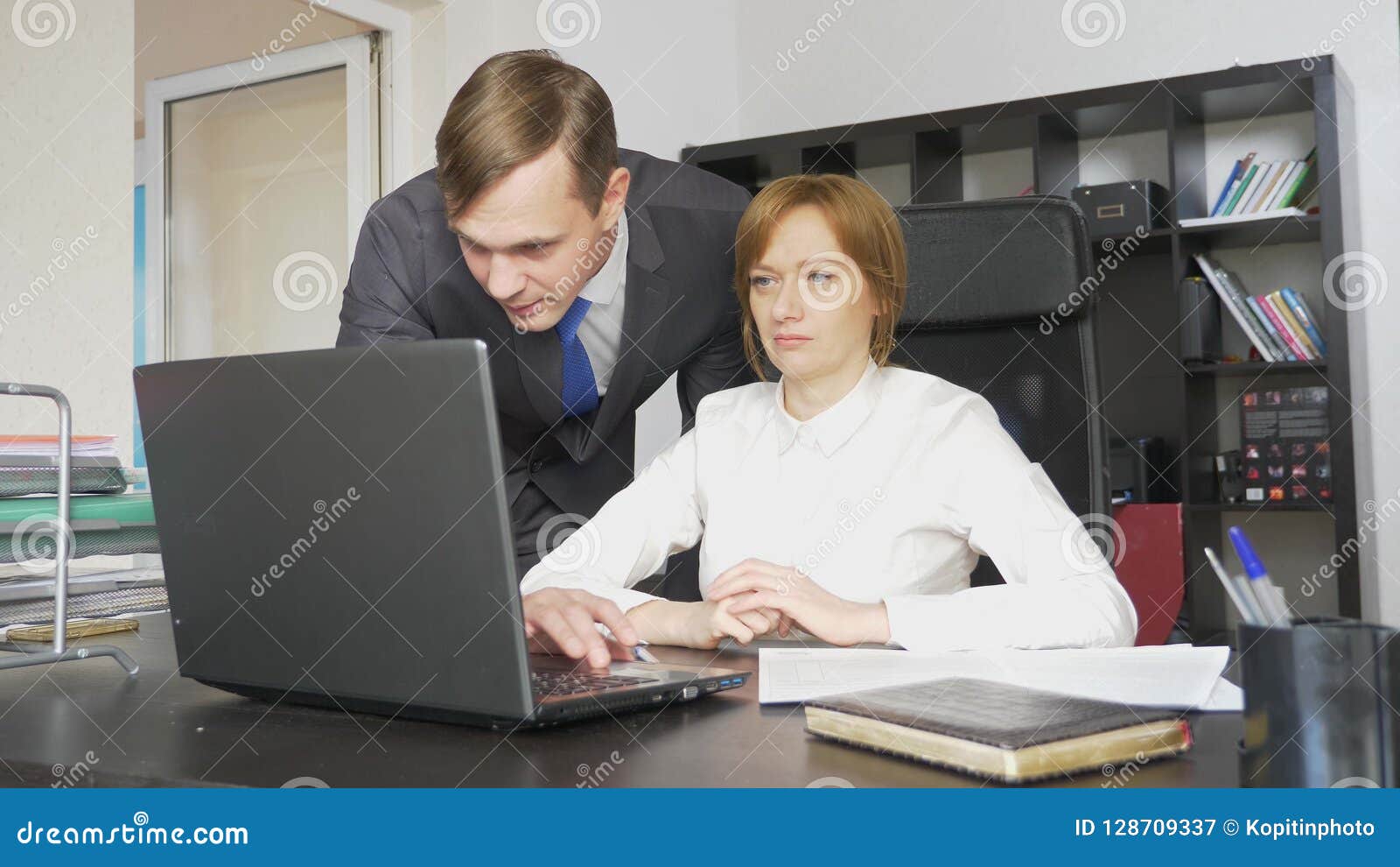 Man and Woman in Strict Suits at Work on Laptop, Documents, Discussion ...