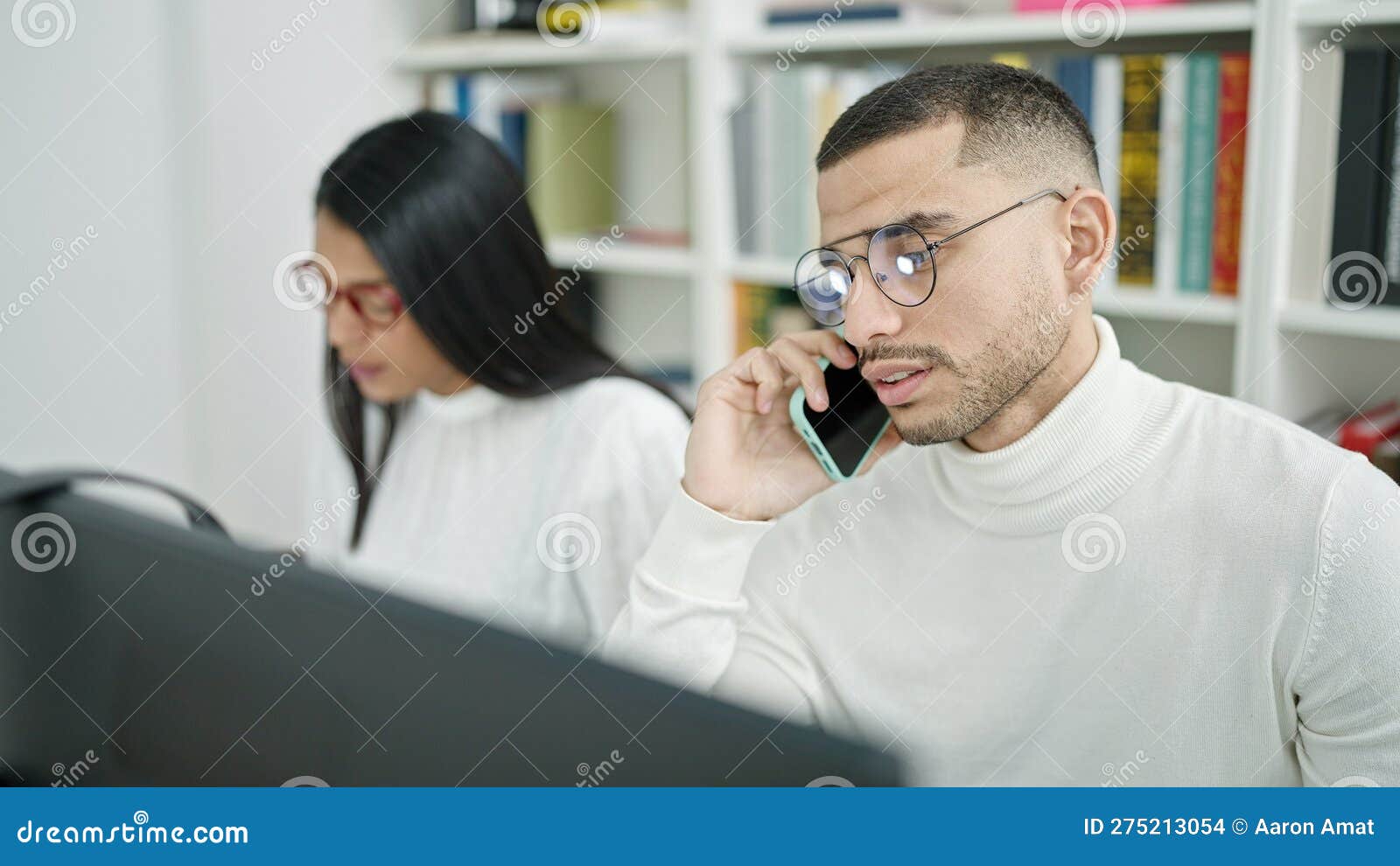 Man and Woman Students Using Computer Talking on Smartphone at ...
