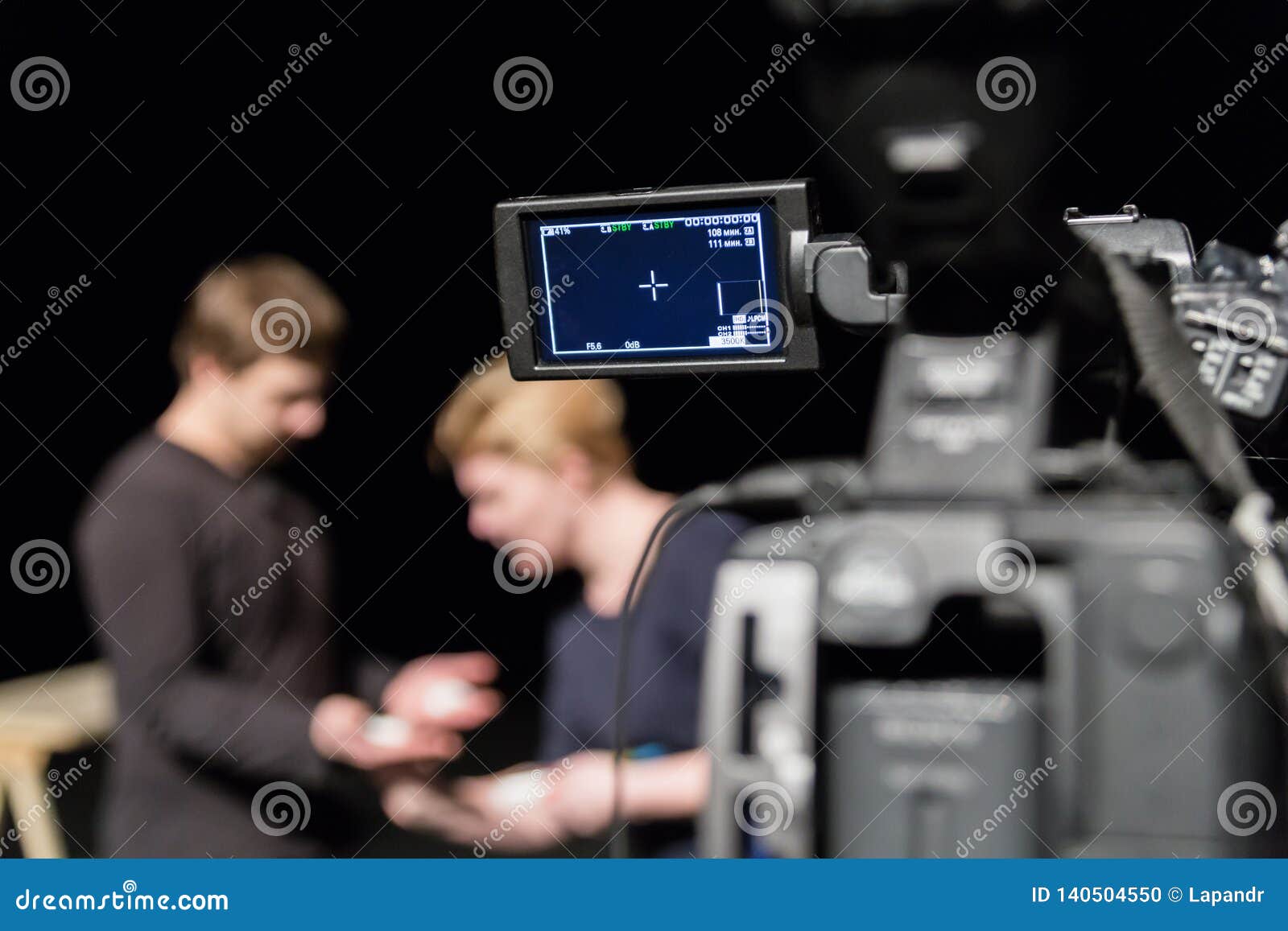 A Man and a Woman in the Studio Preparing To Shoot. Video Camera with ...