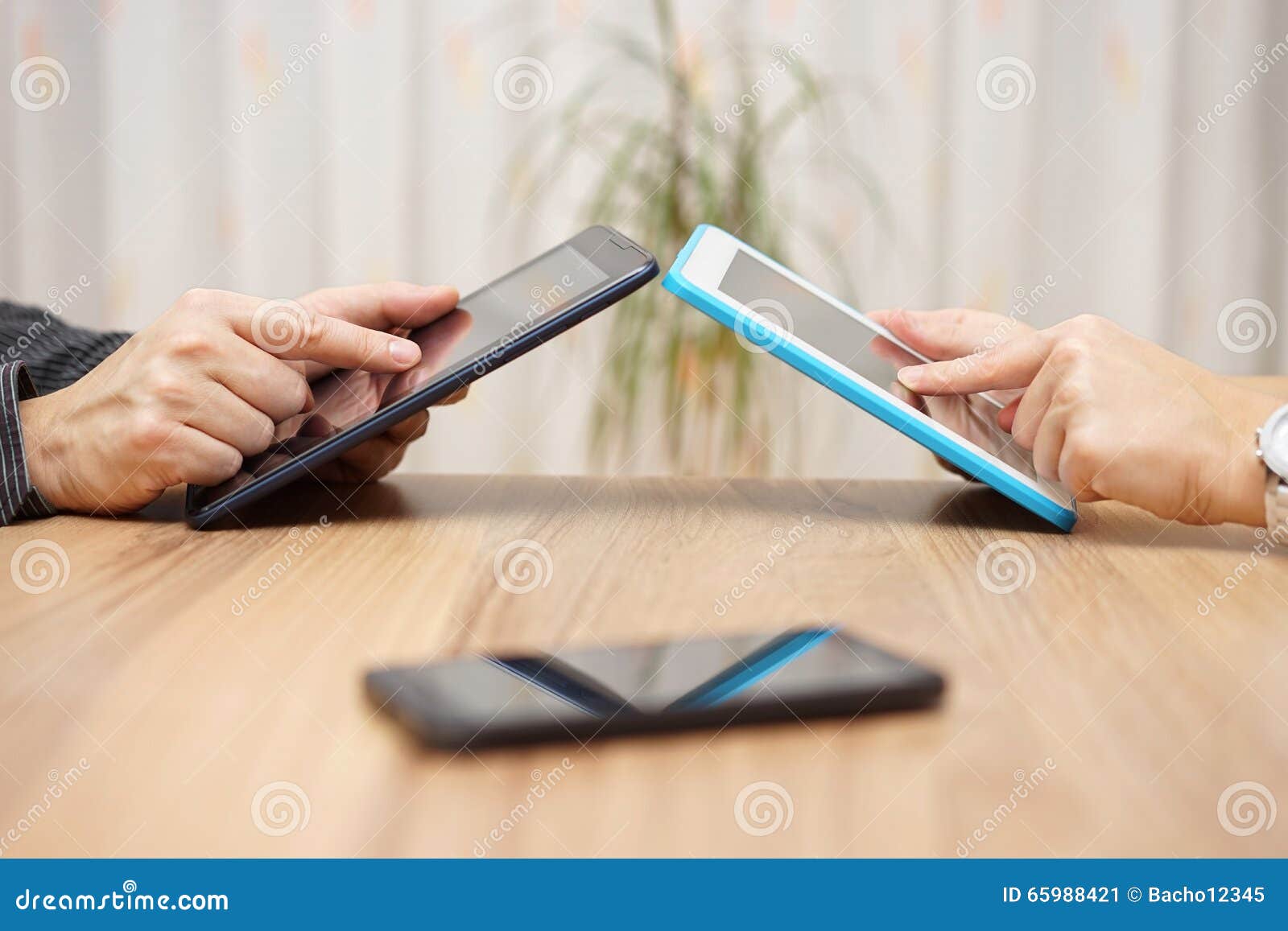 Man and Woman are Using Tablet Computers To Share Music and Data Stock ...