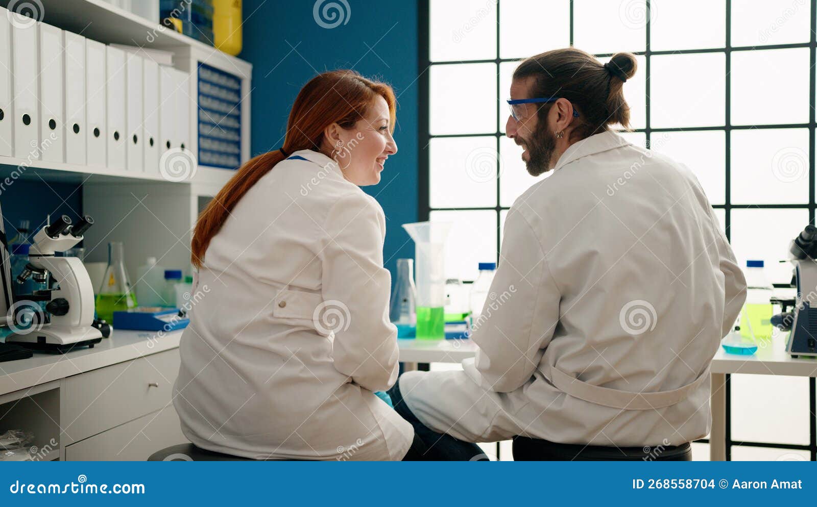 Man and Woman Wearing Sciencist Uniform Speaking at Laboratory Stock ...