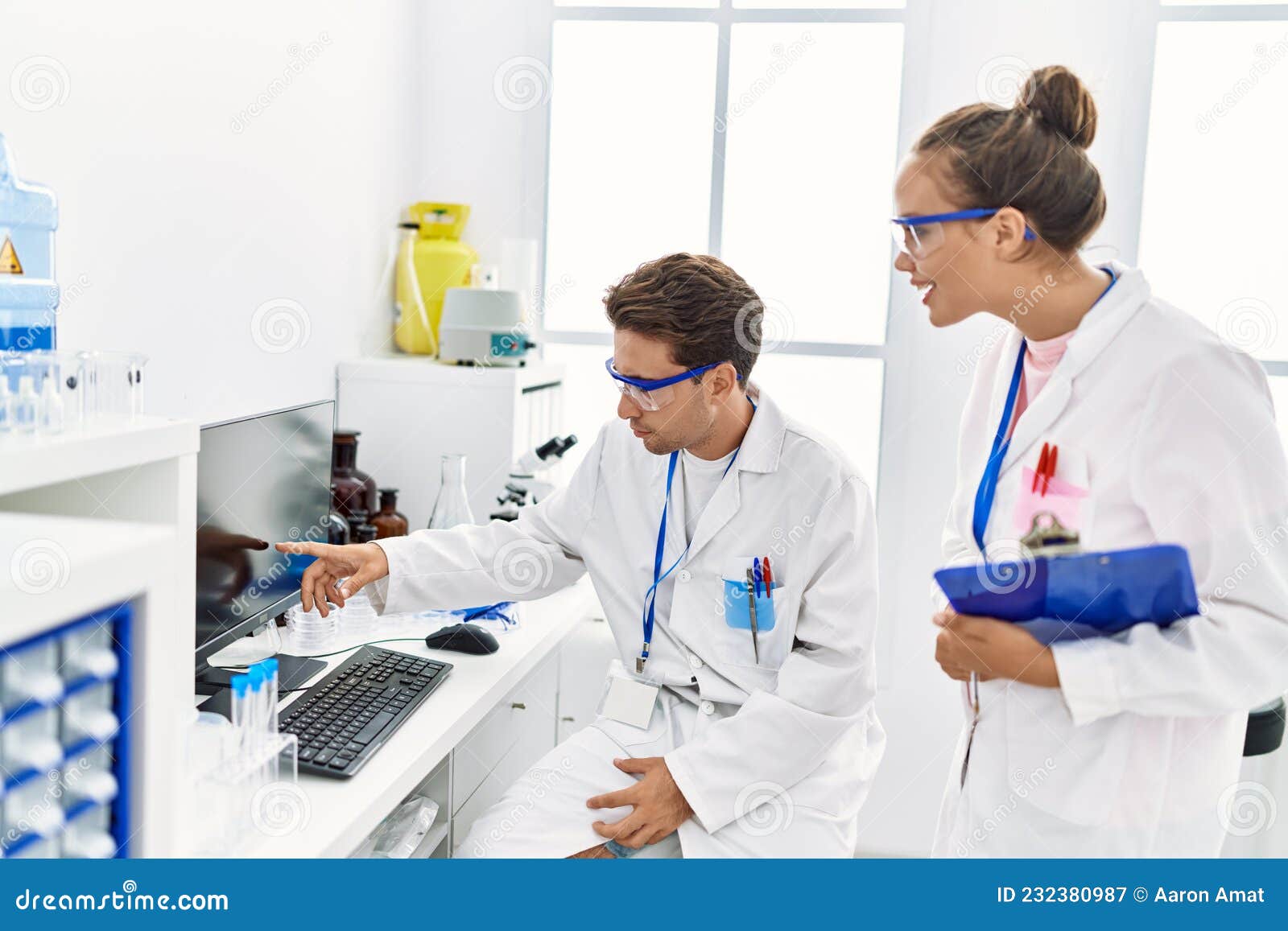 Man and Woman Wearing Scientist Uniform Using Computer Working at ...