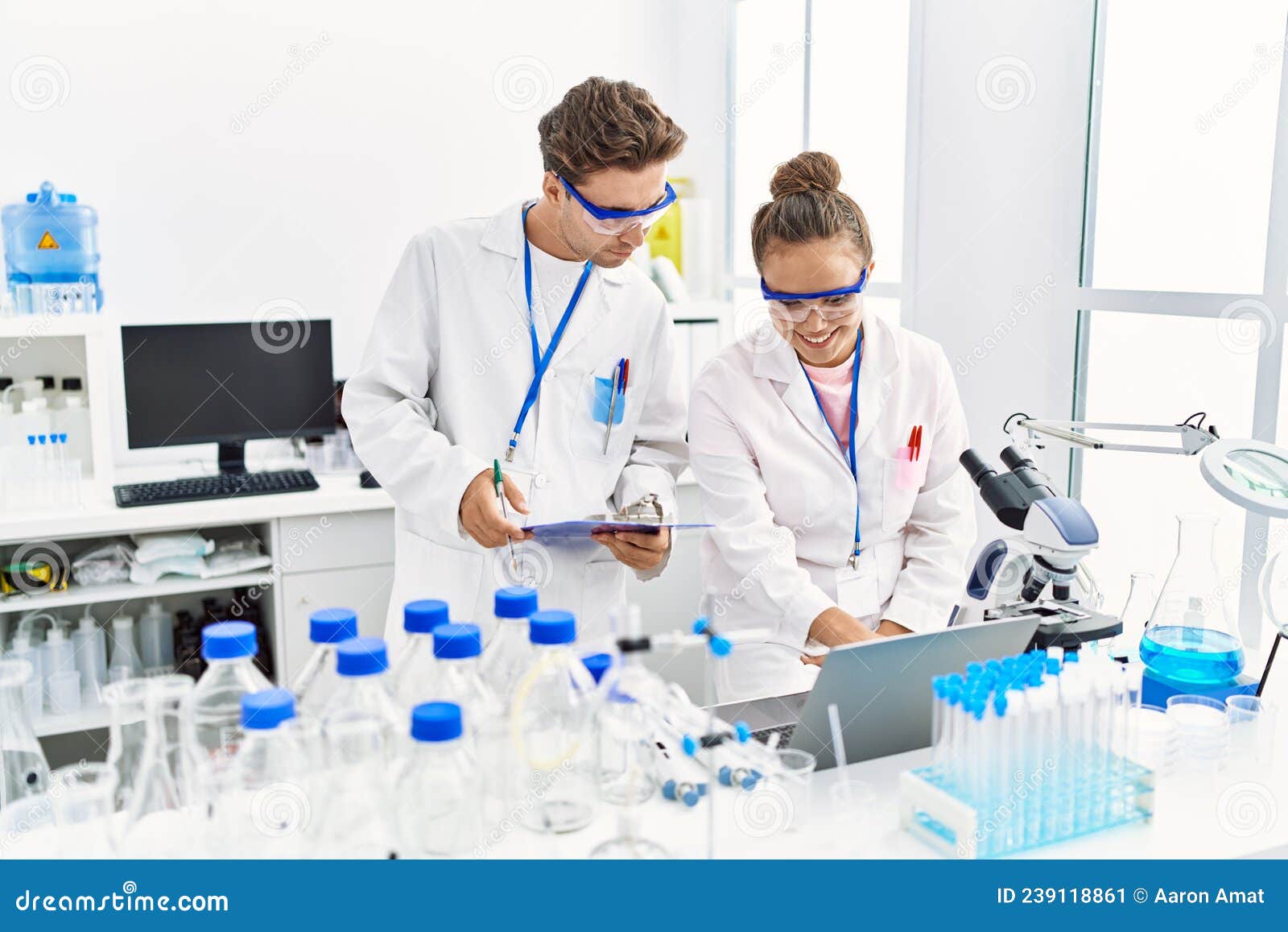 Man and Woman Wearing Scientist Uniform Using Laptop Working at ...
