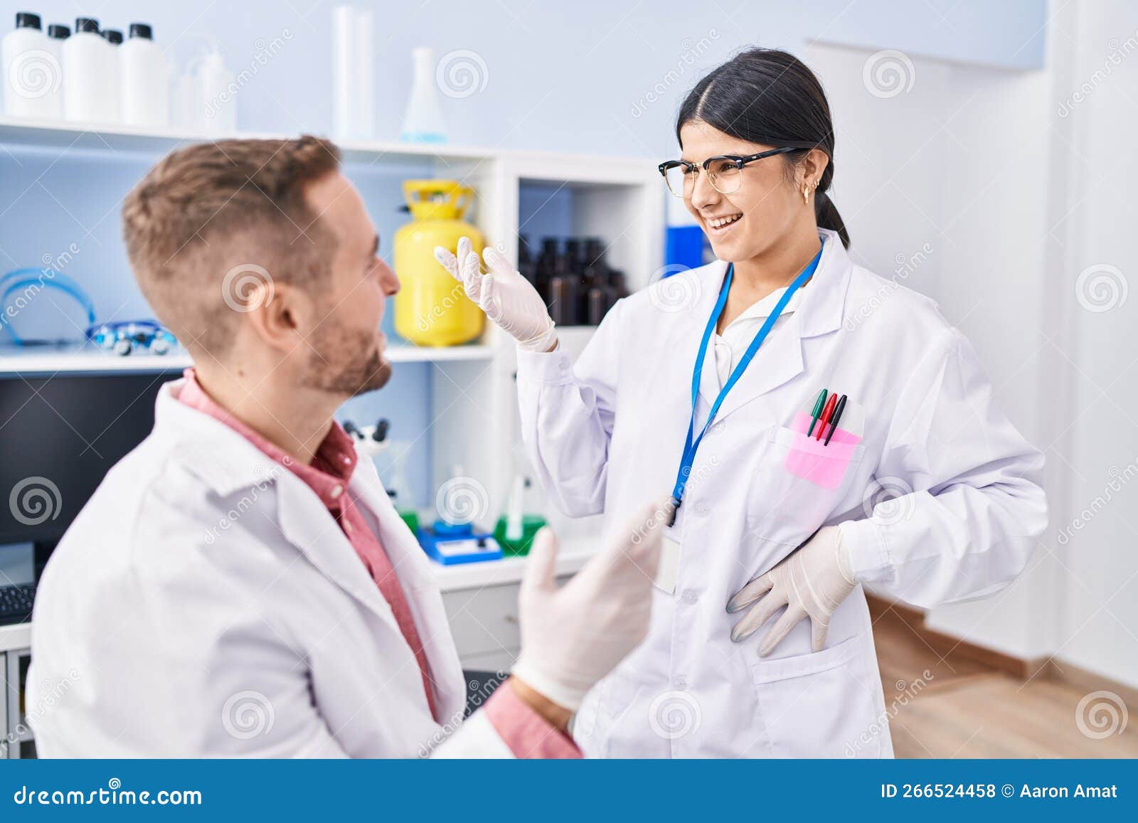 Man and Woman Wearing Scientists Uniform Speaking at Laboratory Stock ...