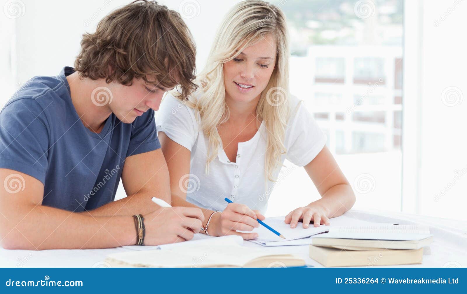 A Man and Woman Working Together at Doing Homework Stock Photo - Image ...