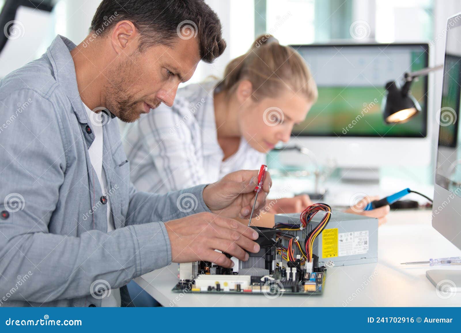 Man and Woman Assembling Computers on Workbench Stock Photo - Image of ...