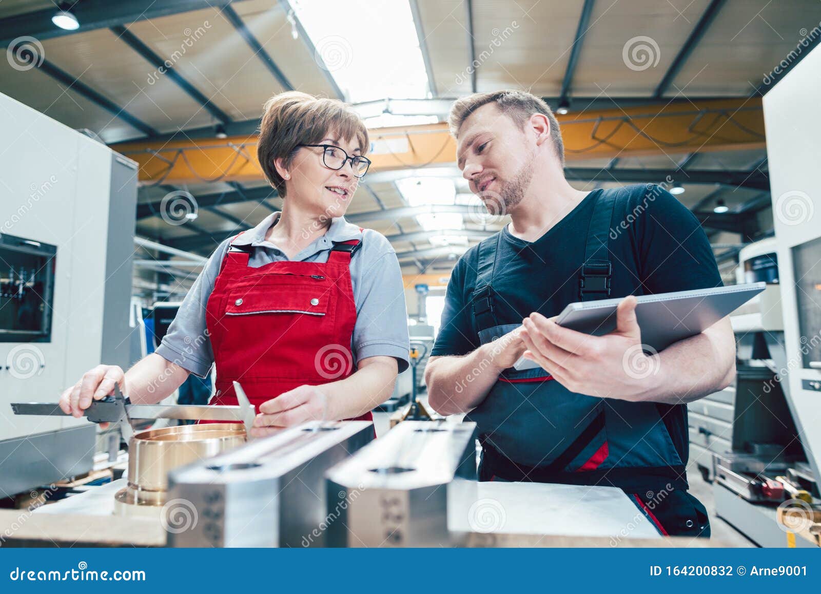 Worker In Metalworking Plant Installing A Rivets Into Part For ...