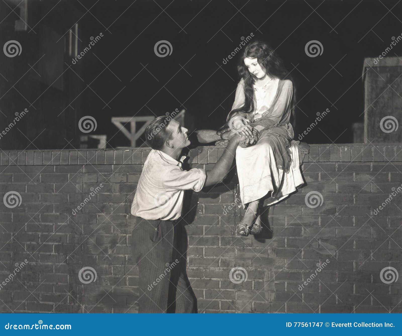 Man Wooing Woman Sitting on Brick Wall Stock Image - Image of face ...