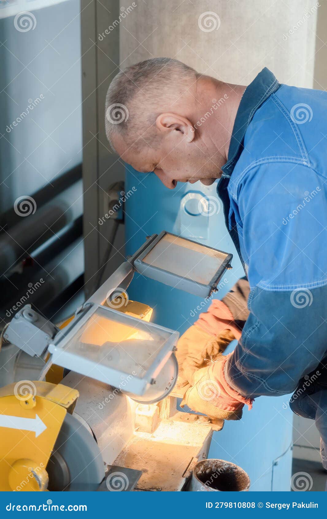 Man in Work Clothes Sharpens Chisel at Grinder. Worker in Turning Shop ...