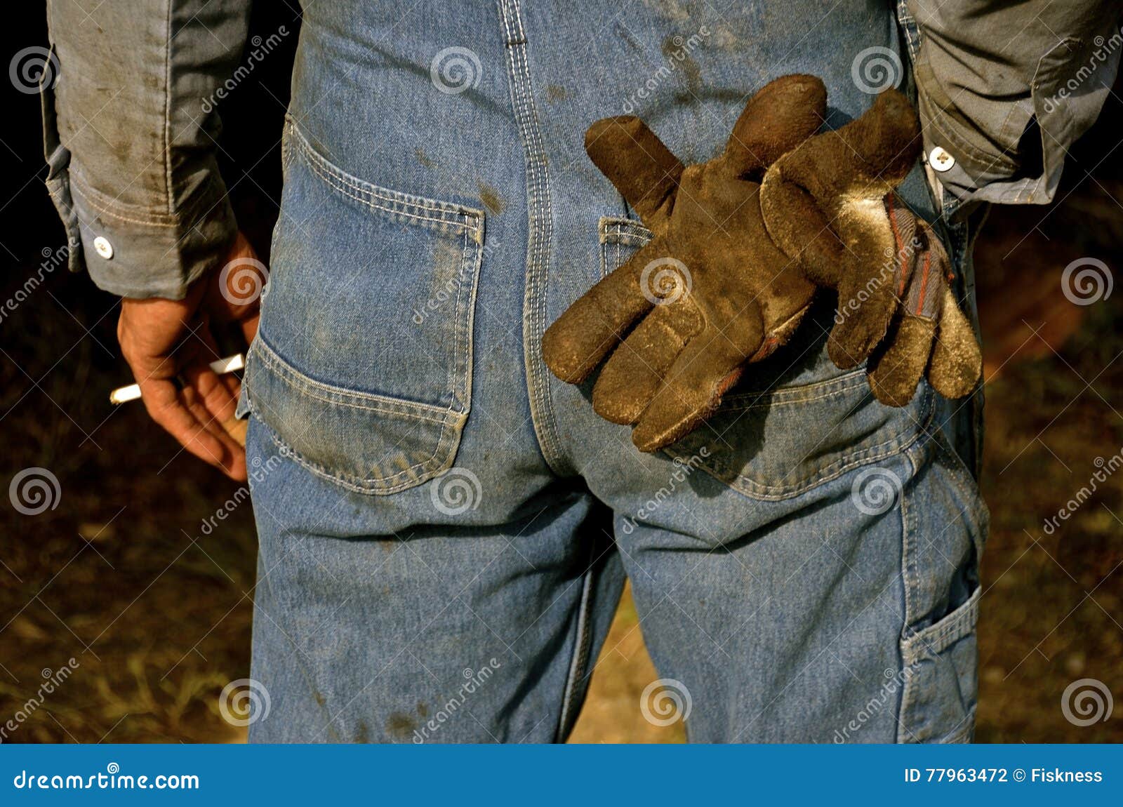 A Man in Work Clothes Smokes Cigarette Stock Photo - Image of back ...