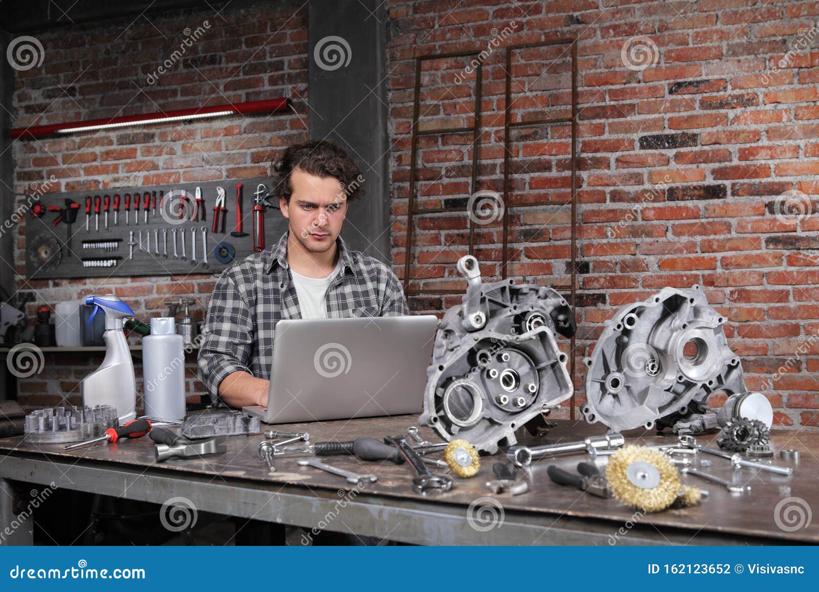 Man Work with Computer Search in Internet Spare Engine Parts on the ...